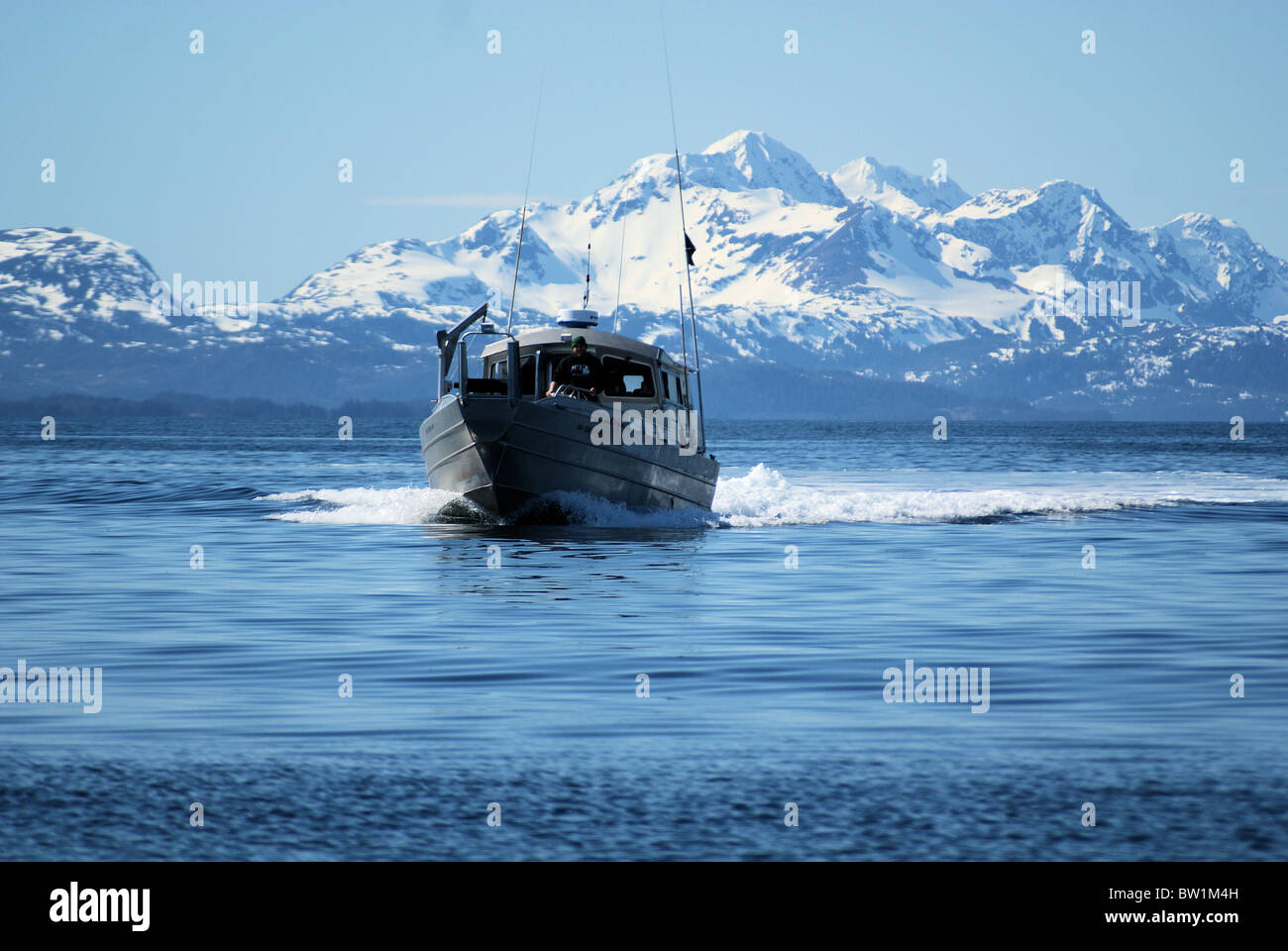 Gill net boat in prince william sound Alaska with mountains in back ...
