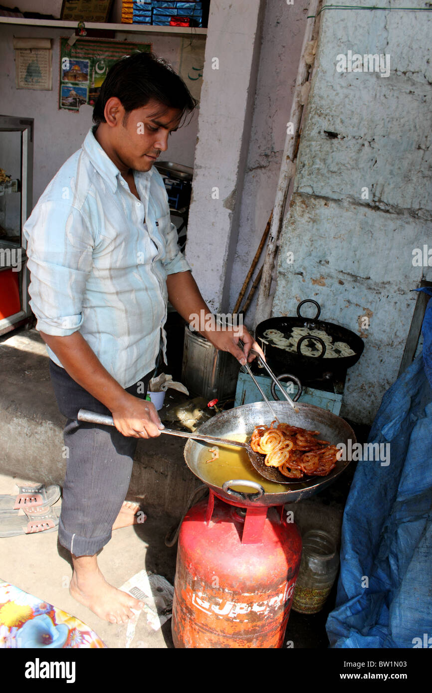 Man cooking (deep frying) Indian sweets (Jalebis) near Charminar ...