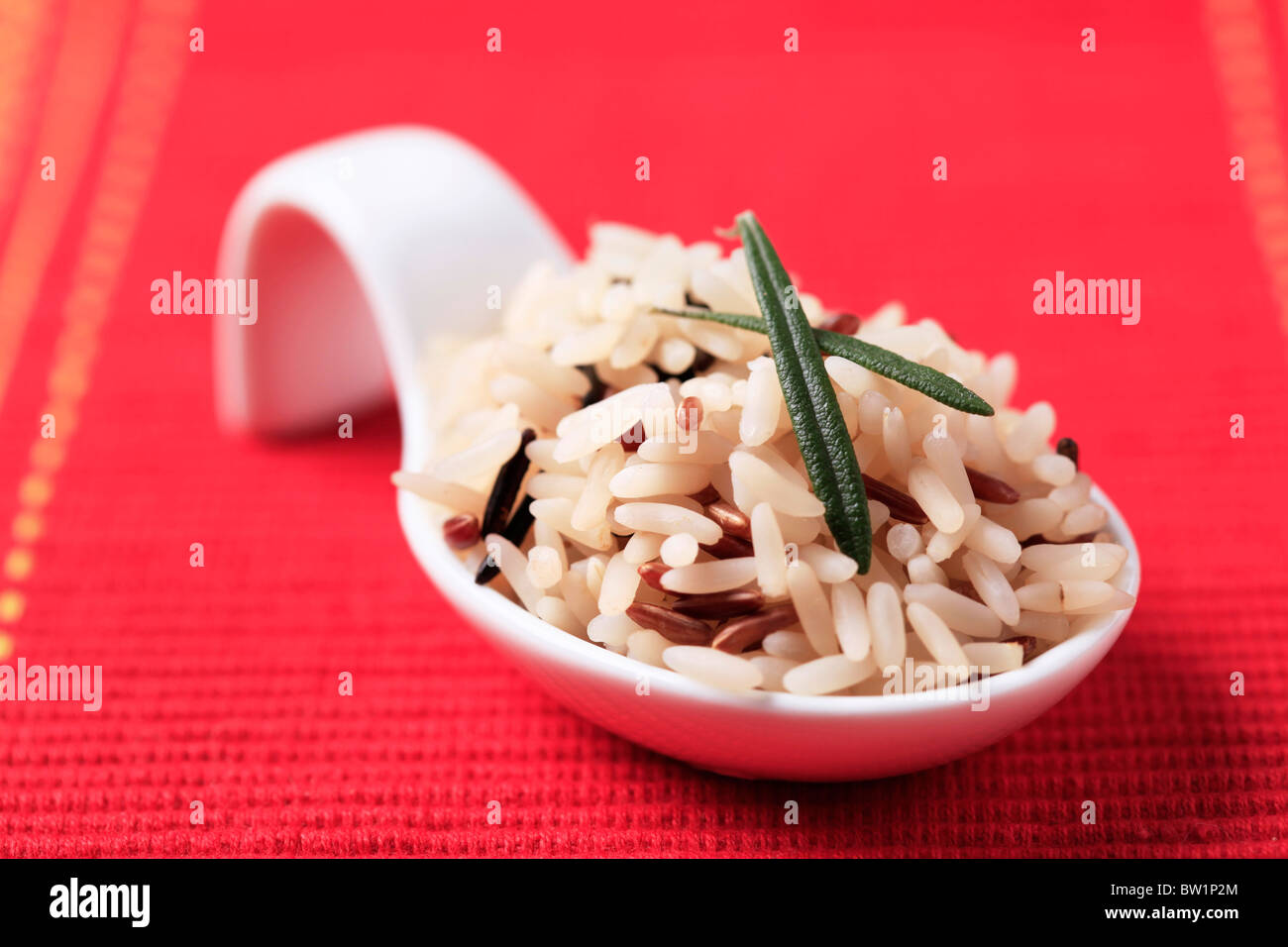 Spoon of cooked mixed rice Stock Photo - Alamy