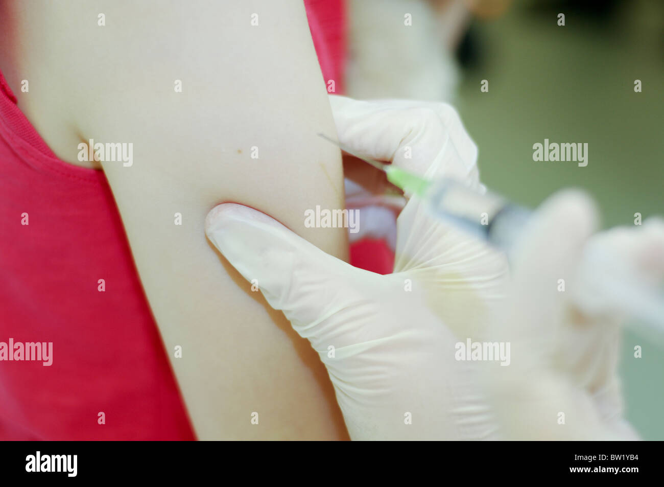 A child in a hospital ward receiving an injection from a nurse Stock ...