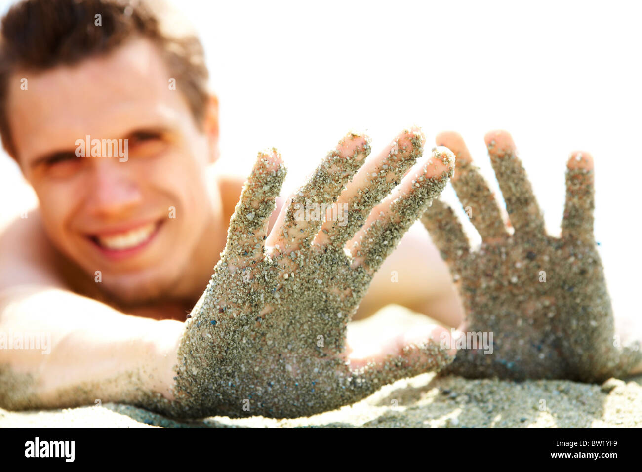 Man lying sand covered hi-res stock photography and images - Alamy