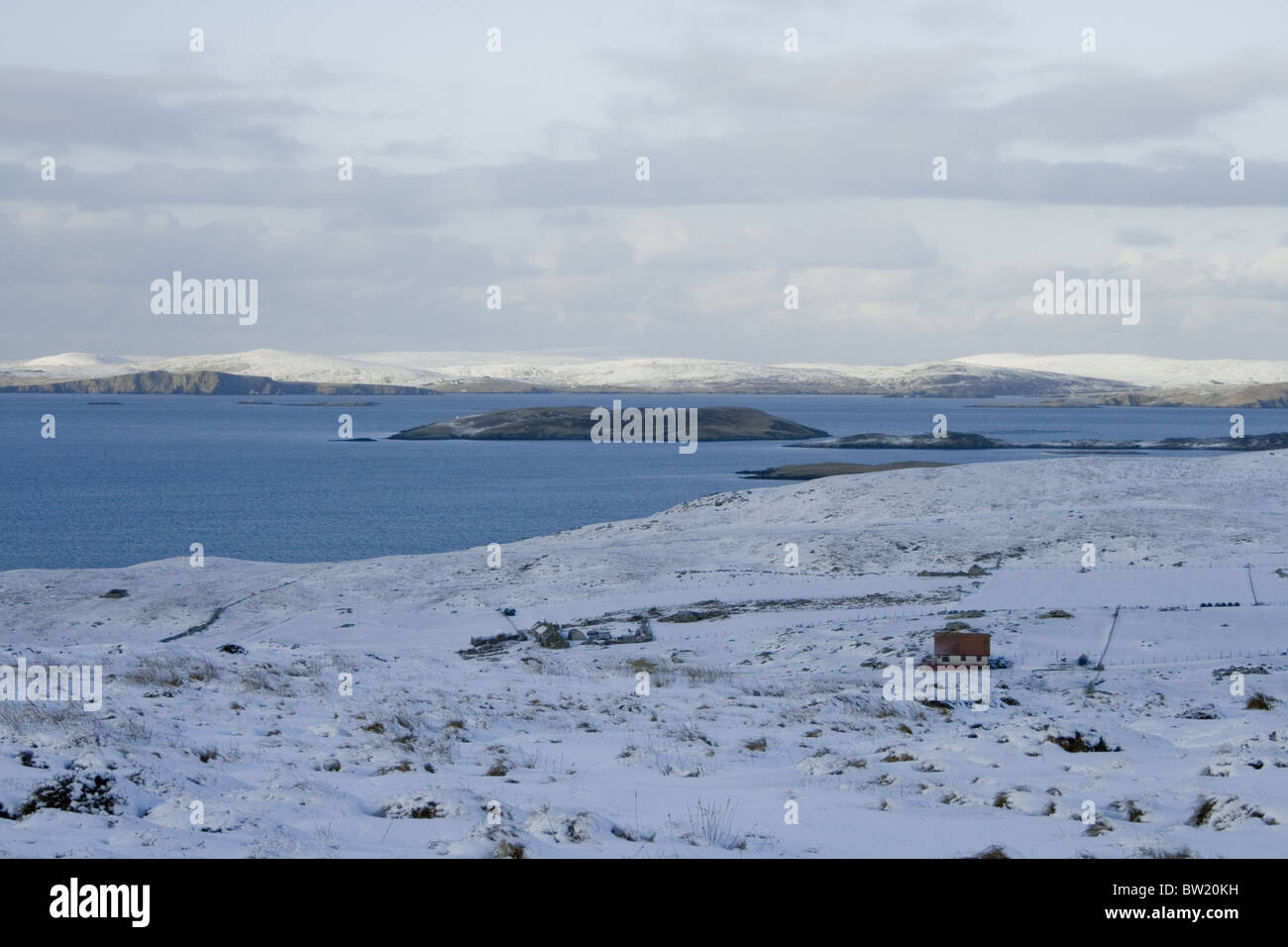 a single house alone in the snow with the sea and islands in the ...