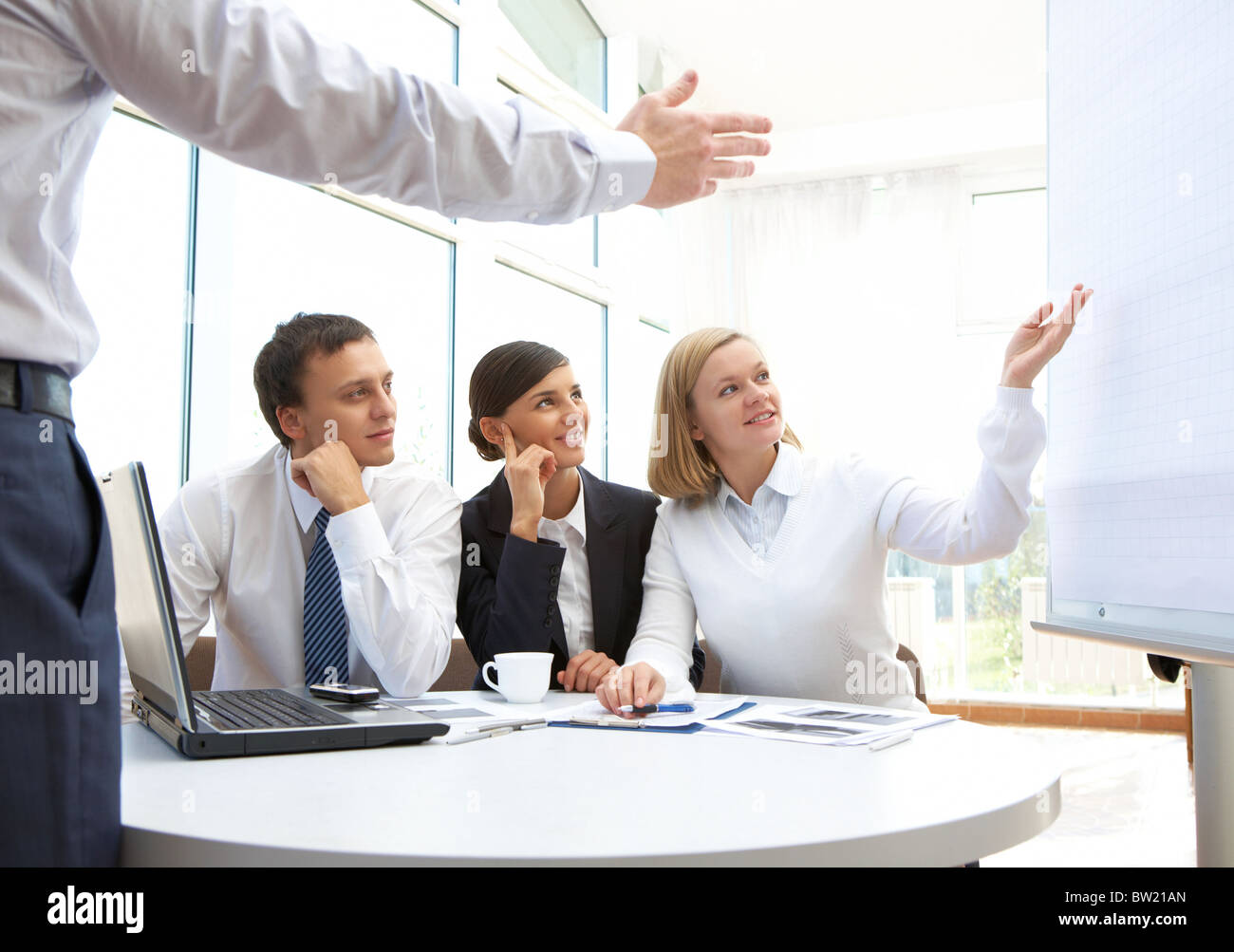 Image of businesspeople pointing at board during presentation Stock ...