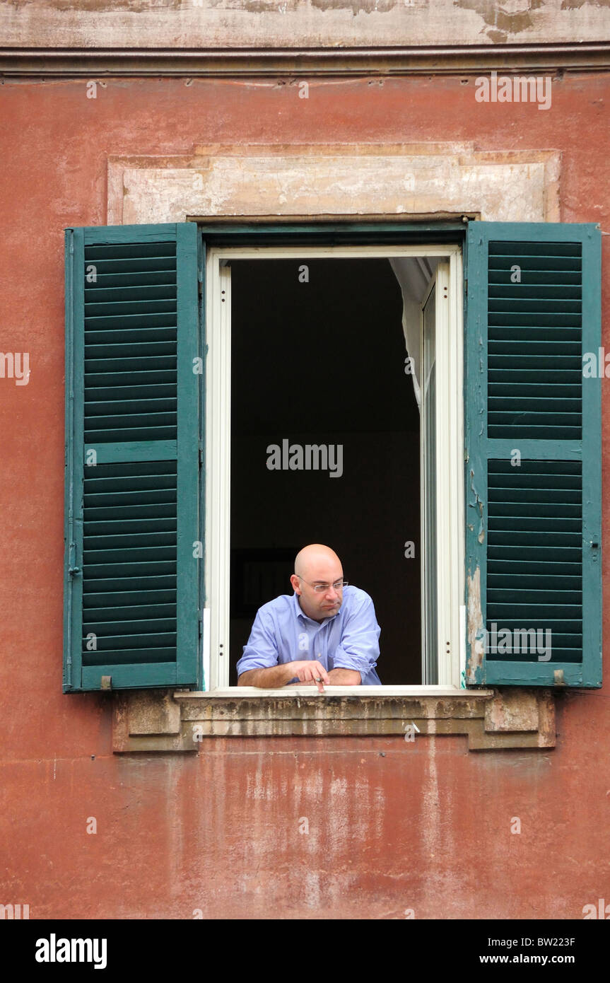 Man at shuttered window Stock Photo - Alamy