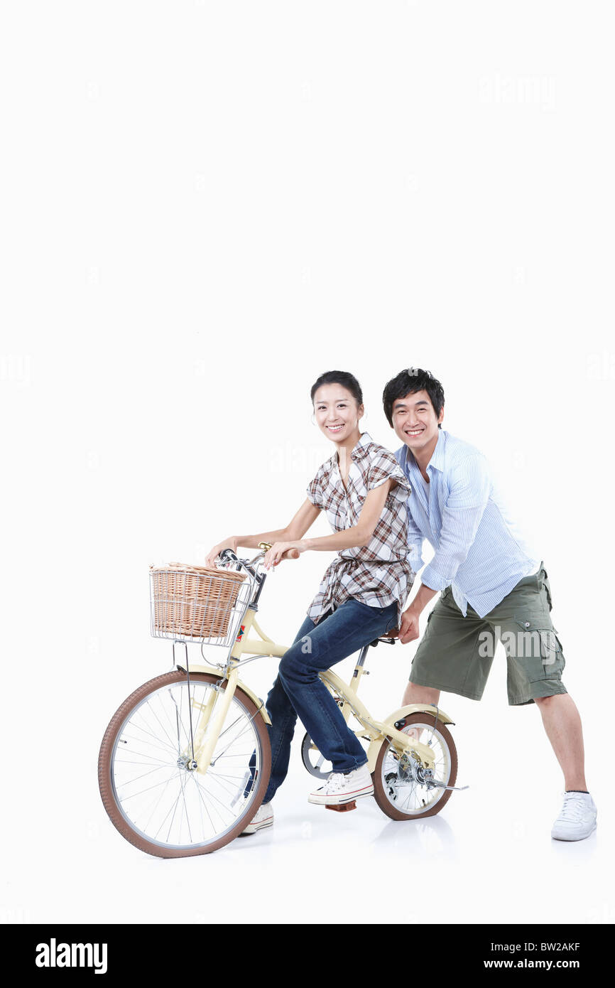 Man riding bicycle with woman Cut Out Stock Images & Pictures - Alamy