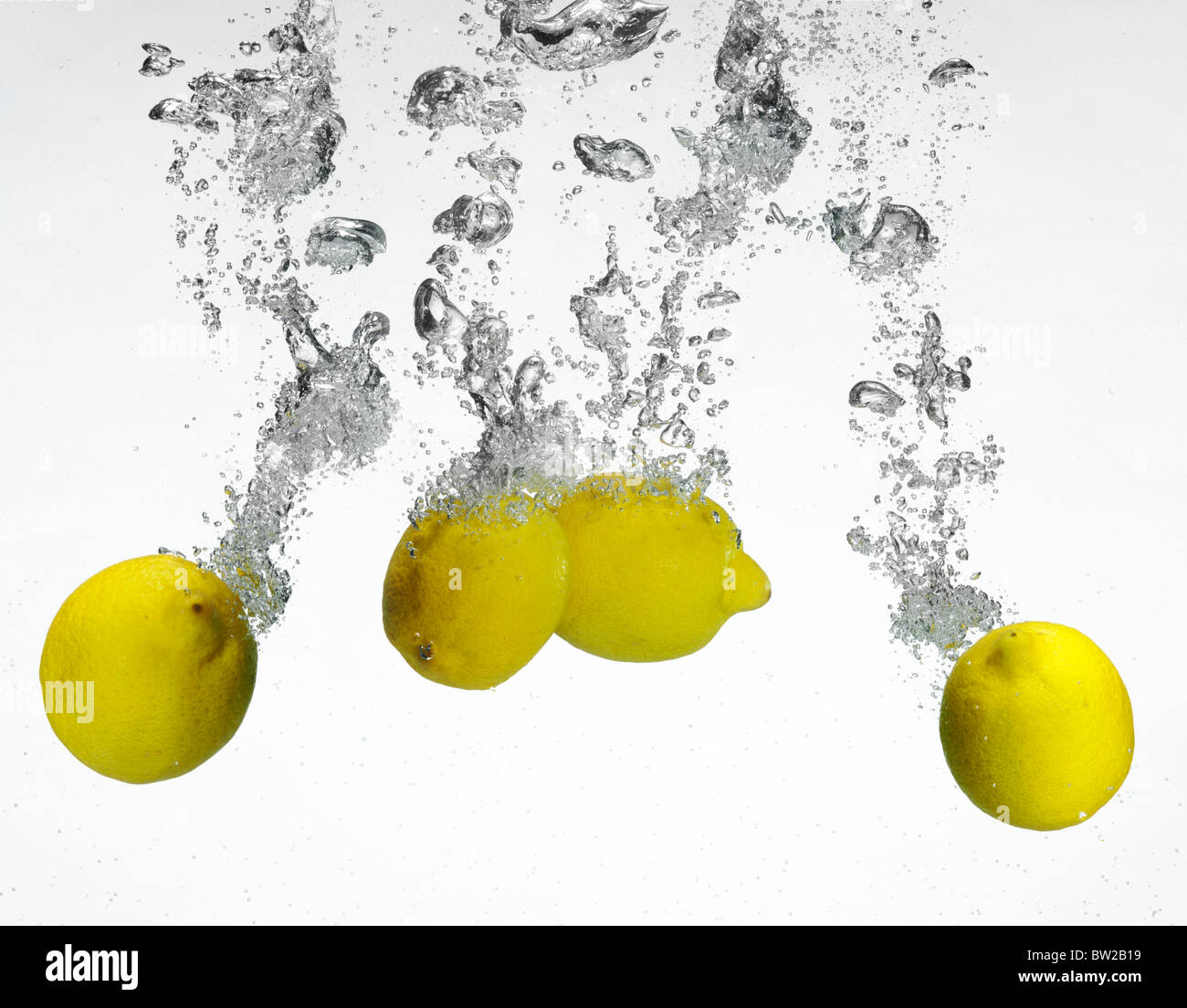 Lemon falling in water close-up Stock Photo - Alamy