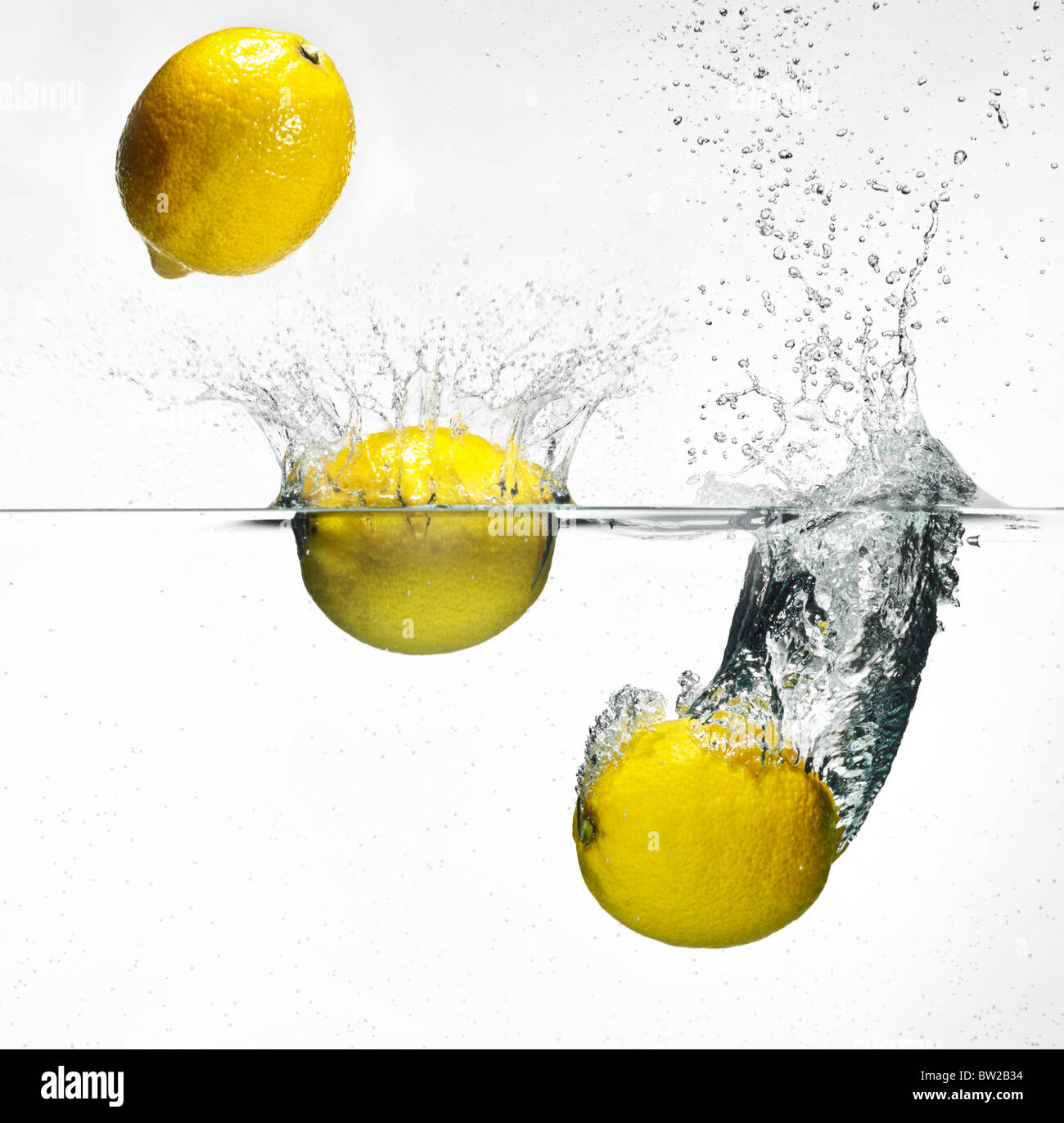 Lemon falling in water close-up Stock Photo - Alamy