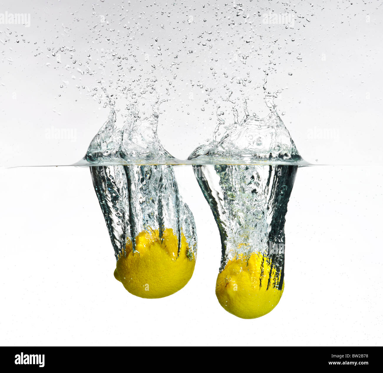 Lemon falling in water close-up Stock Photo - Alamy