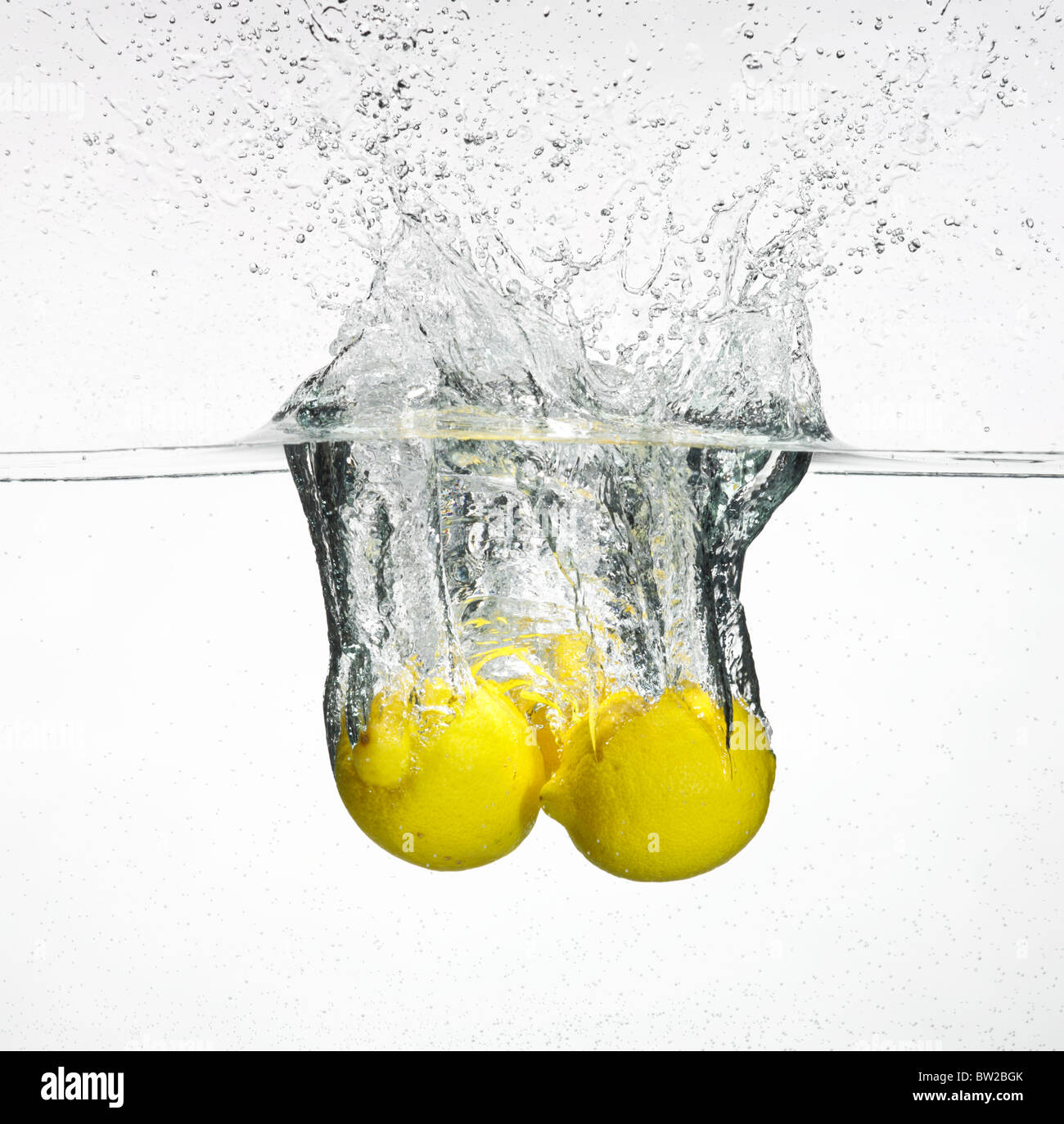 Lemon falling in water close-up Stock Photo - Alamy