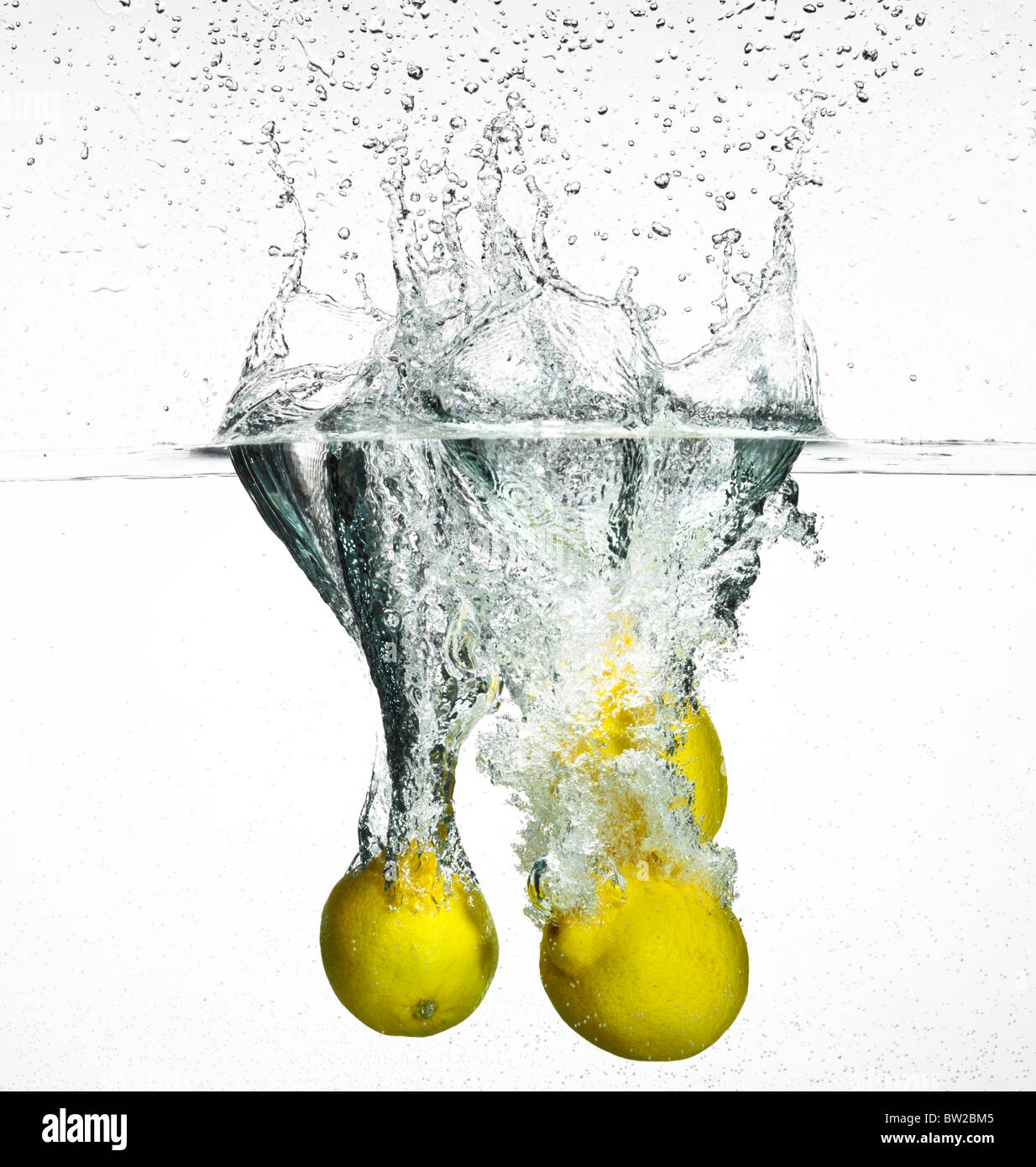Lemon falling in water close-up Stock Photo - Alamy
