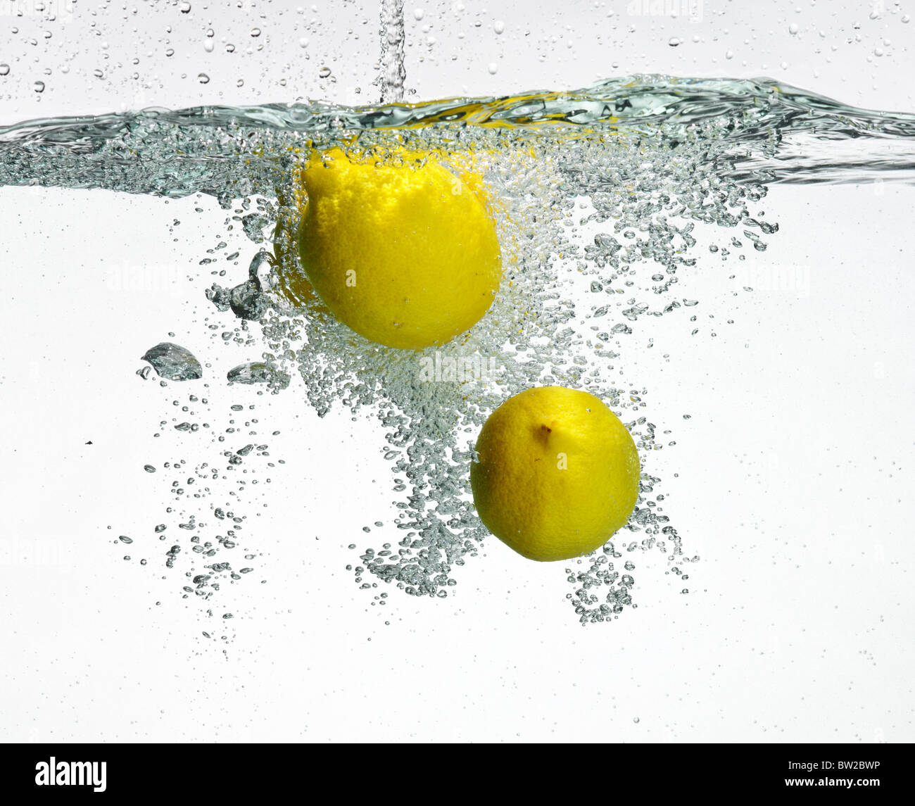 Lemon falling in water close-up Stock Photo - Alamy
