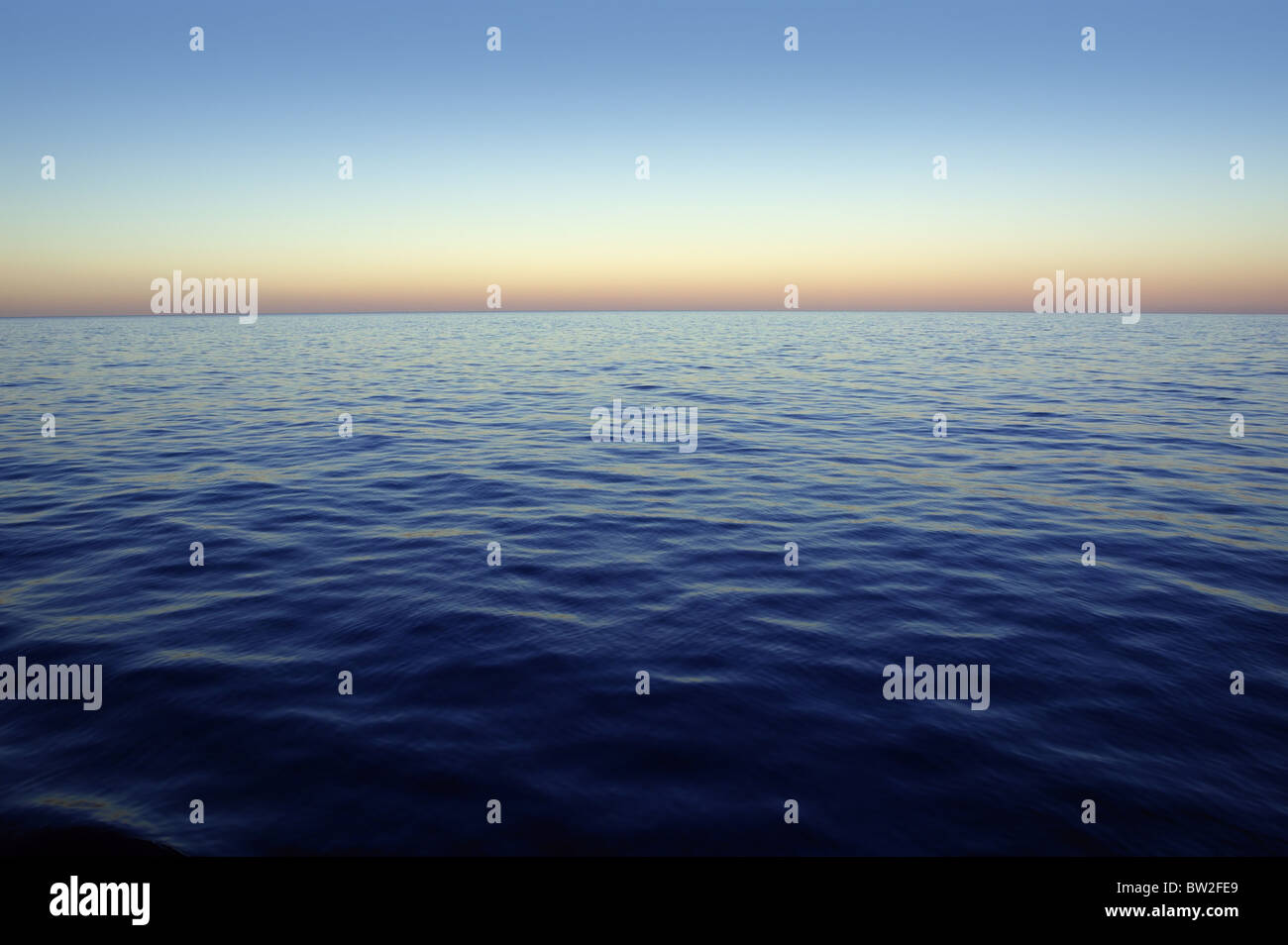 Beautiful sunset sunrise over blue sea ocean in red sky Stock Photo - Alamy