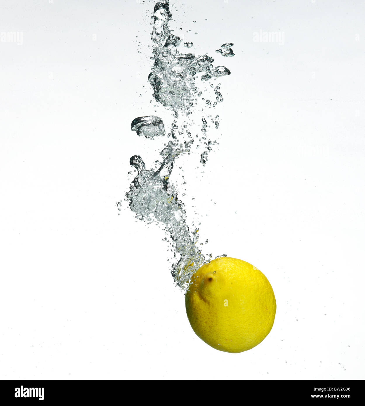 Lemon falling in water close-up Stock Photo - Alamy