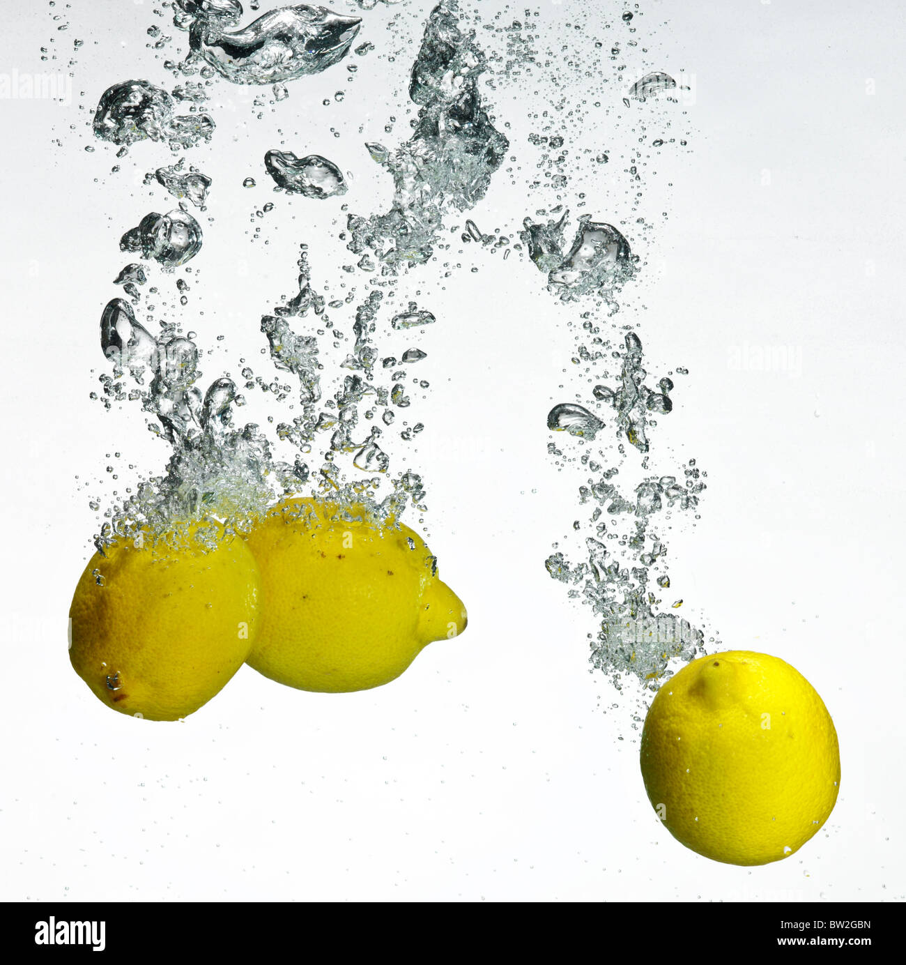 Lemon falling in water close-up Stock Photo - Alamy