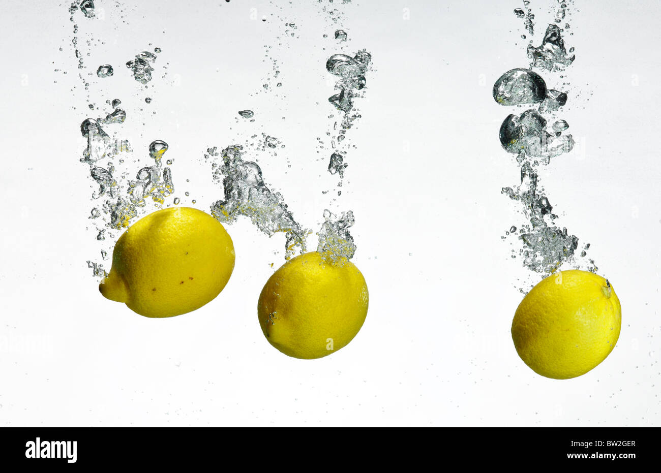 Lemon falling in water close-up Stock Photo - Alamy