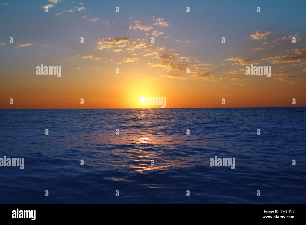 Sunrise sunset in ocean blue sea horizon glowing orange golden sun ...