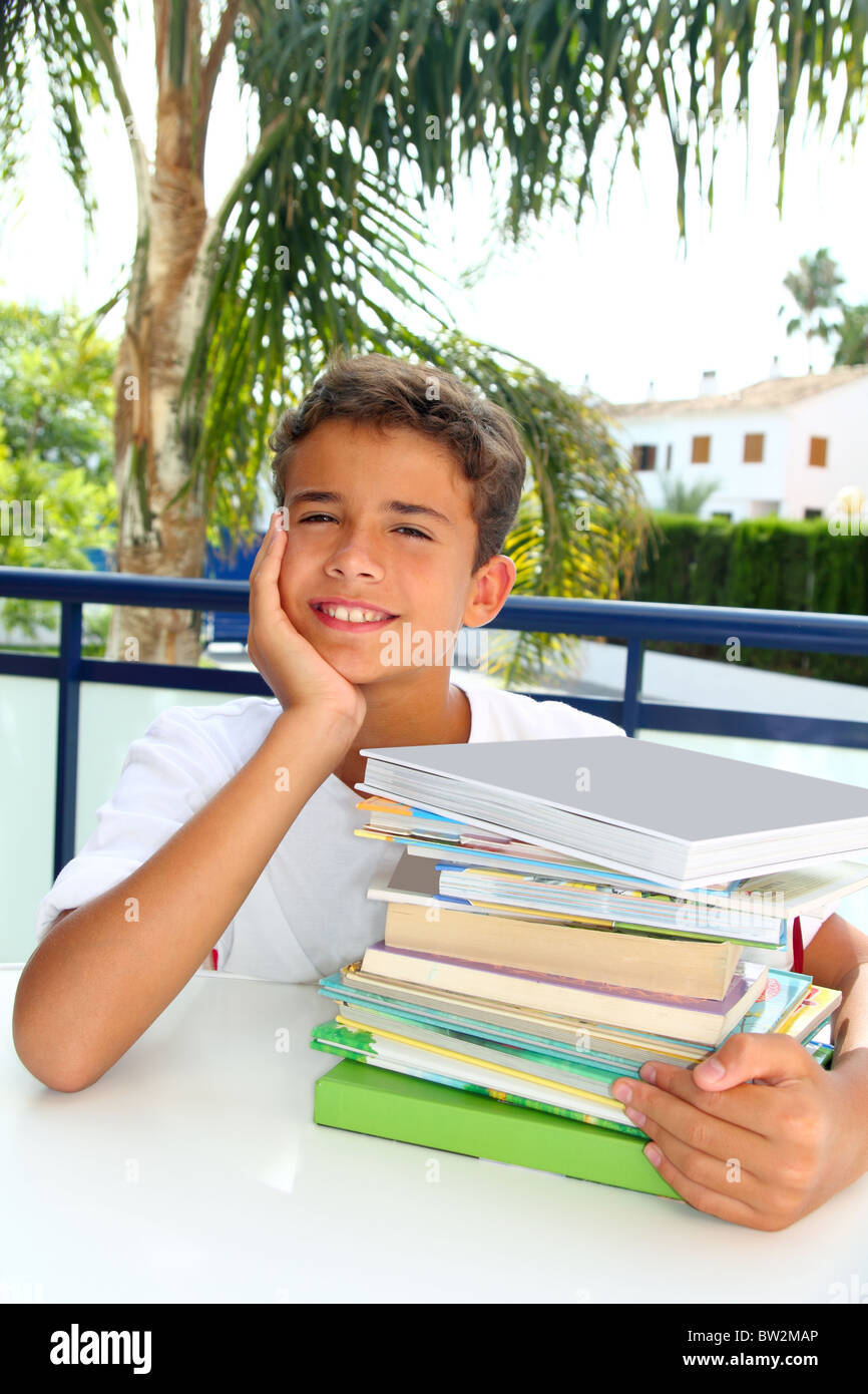 boy student teenager happy thinking with books stacked outdoors Stock ...