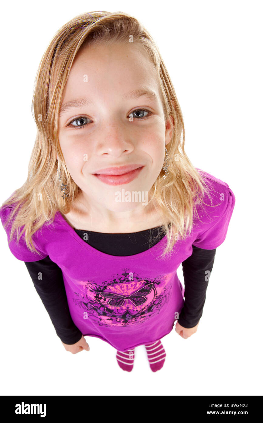 teenage girl in studio seen from above; big head little feet over white ...
