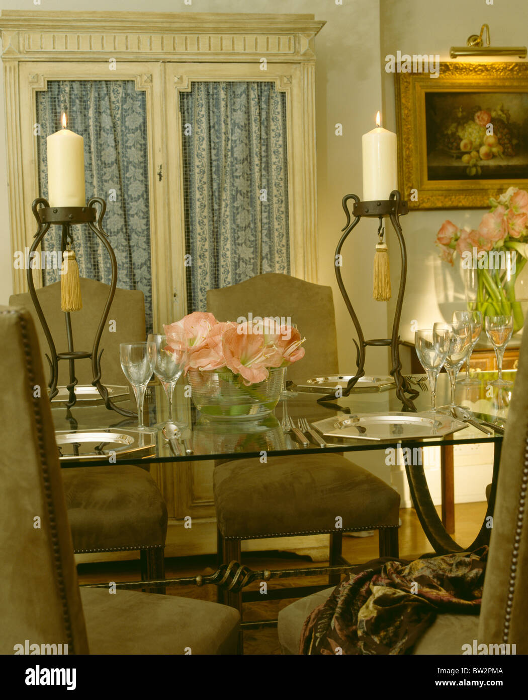 Tall candlesticks on glass-topped table in townhouse dining room Stock ...