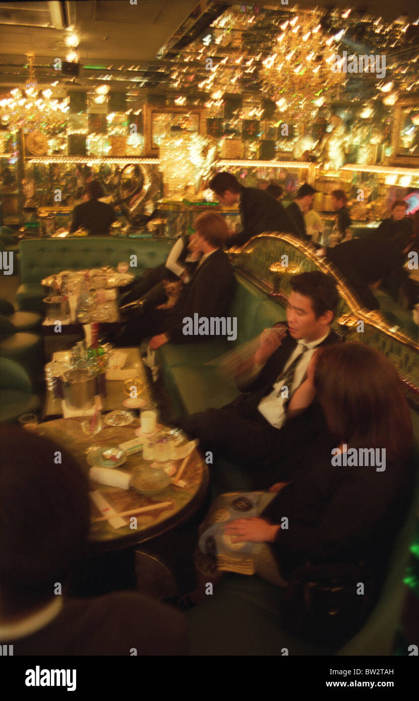 Male hosts entertain their female clientele in a host club in the ...