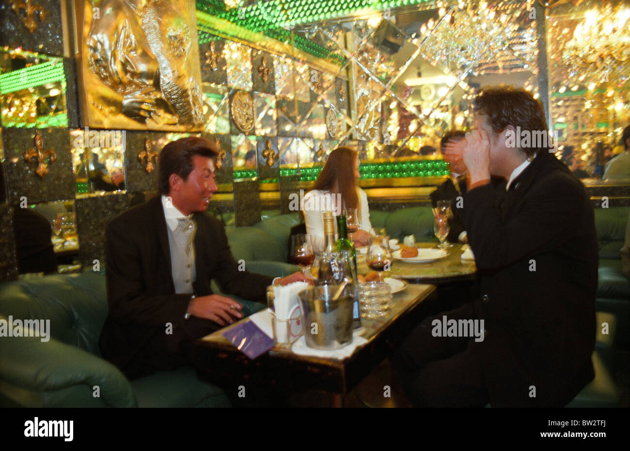 Male hosts entertain their female clientele in a host club in the ...