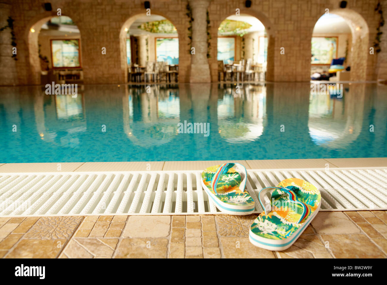 Photo of flip flops in swimming pool Stock Photo - Alamy