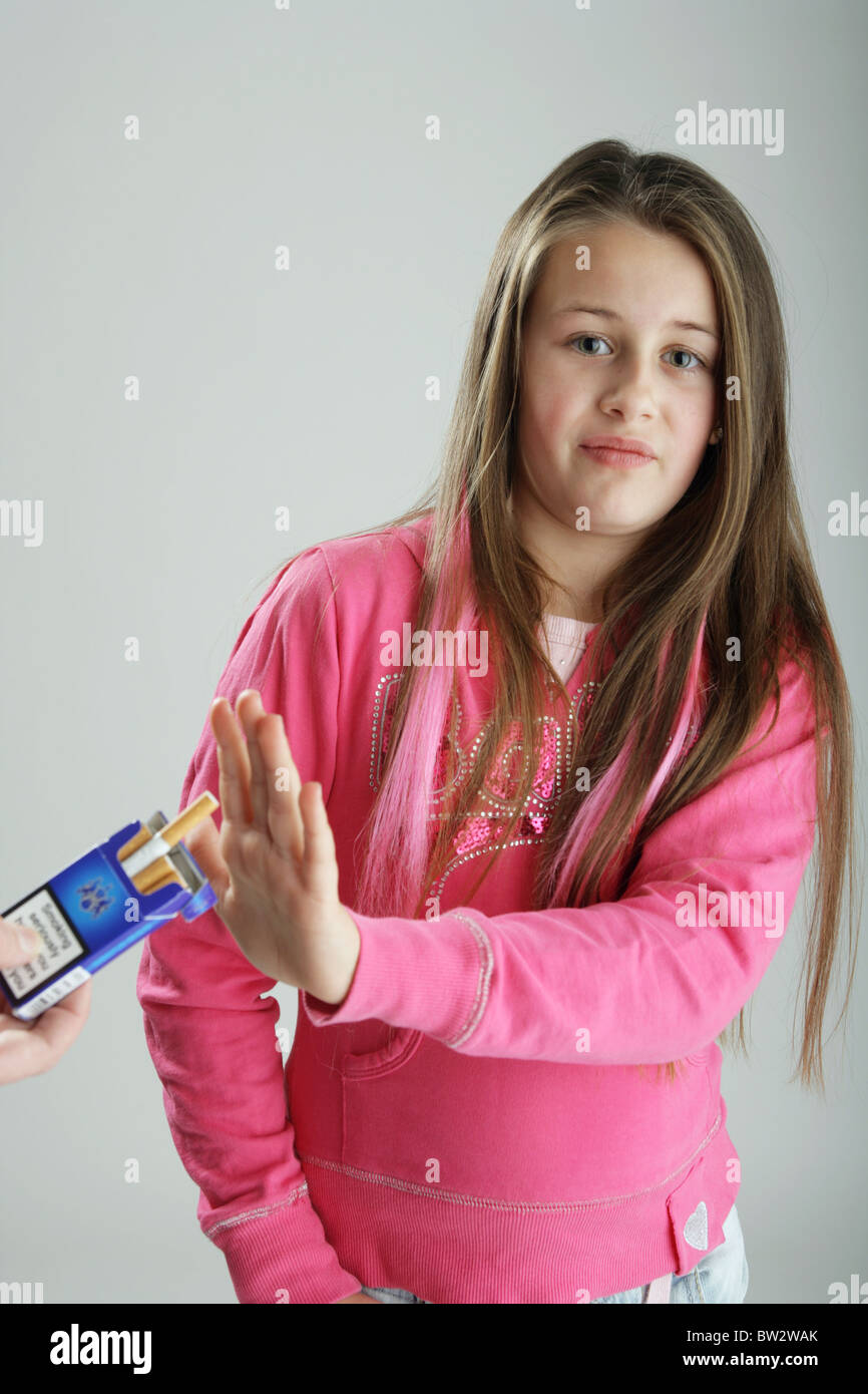 Ten year old girl pushing away a pack of cigarettes Stock Photo - Alamy