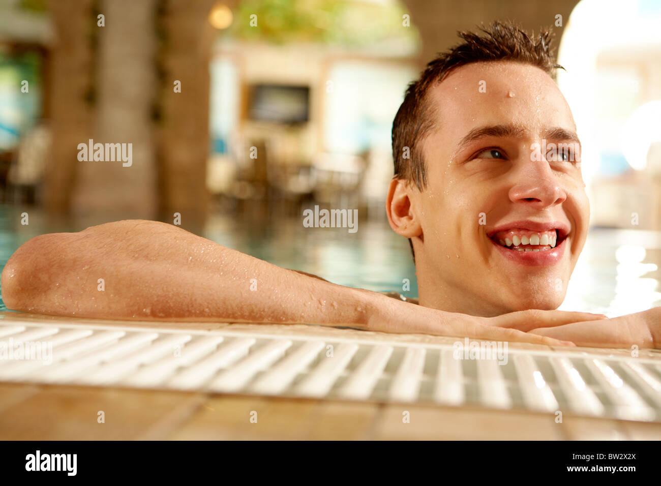 Portrait of happy guy laughing in swimming pool Stock Photo - Alamy