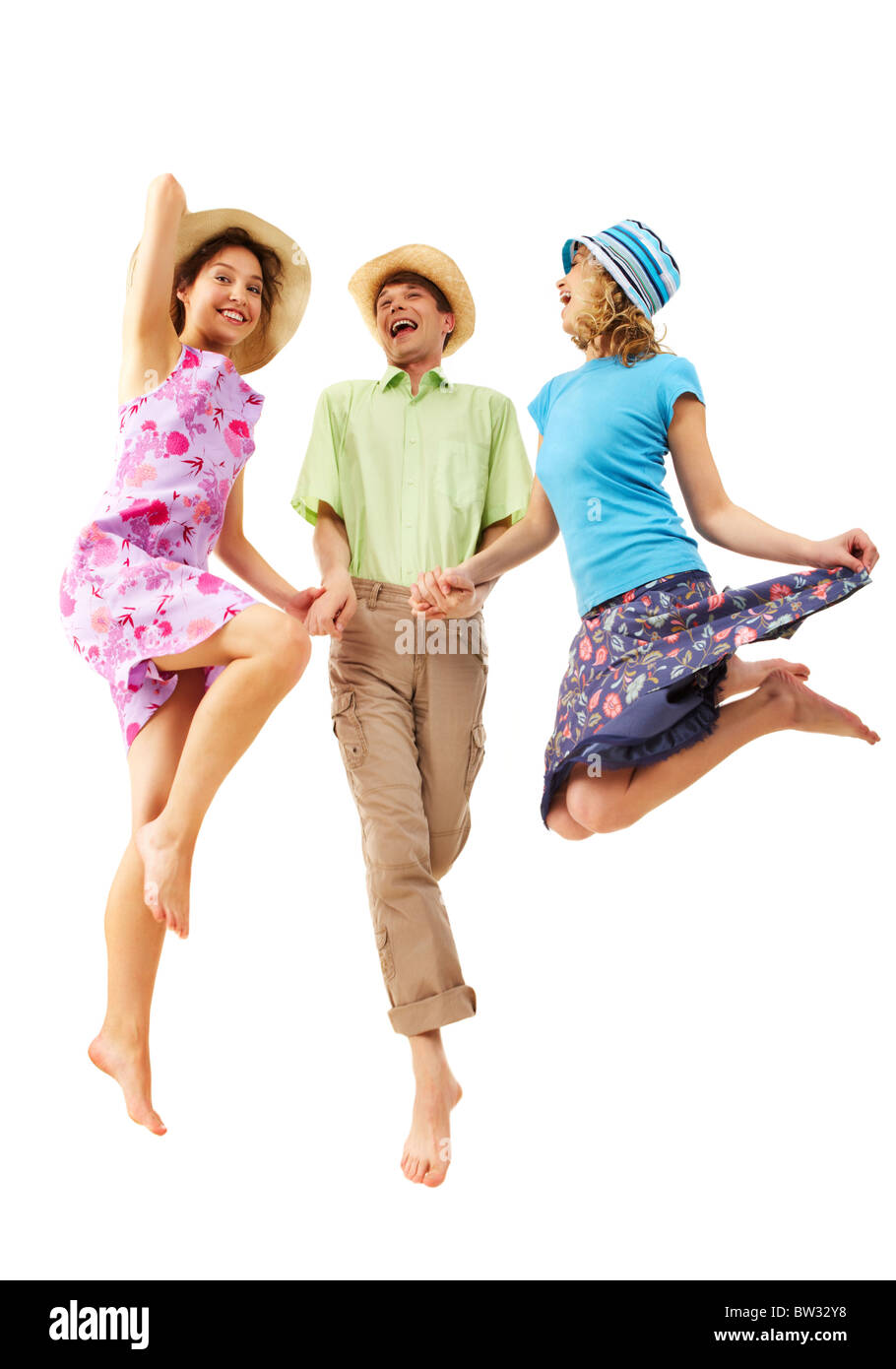 Portrait Of Joyful Girls In Jump Holding Happy Man By Hands In