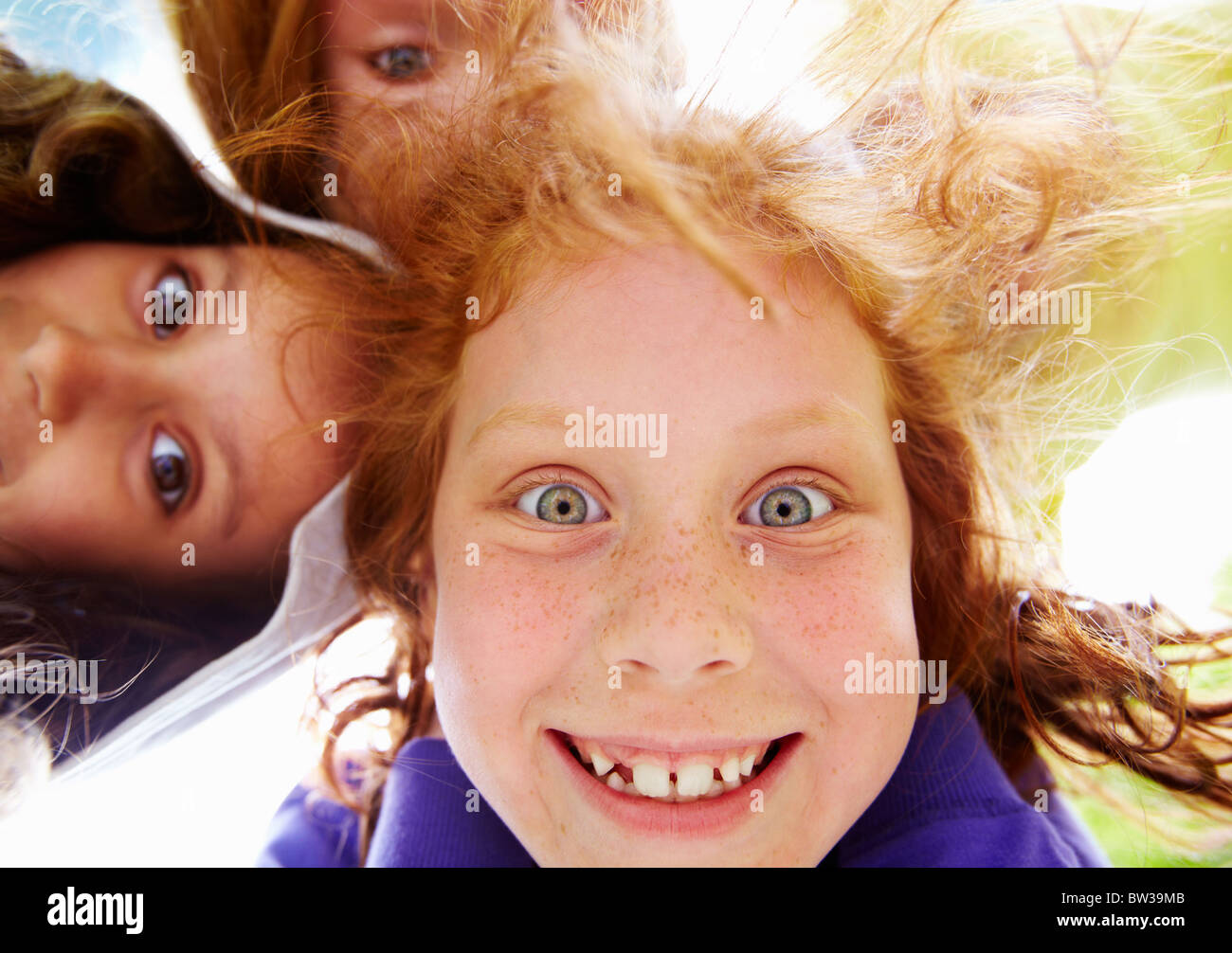 Below view of happy girl with funny expression staring at you Stock ...