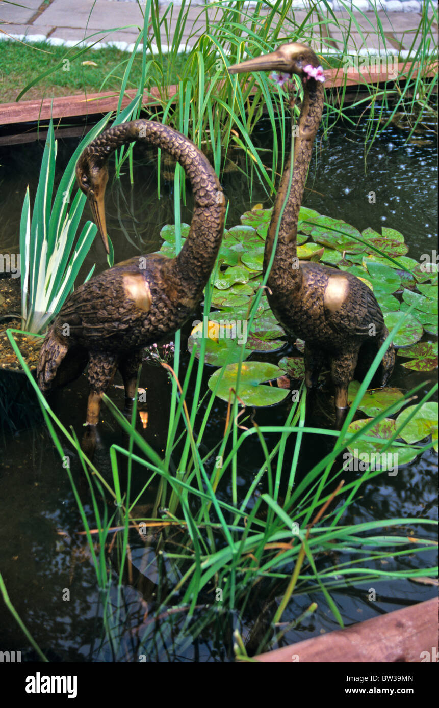 Two decorative sculptured birds in a garden pond Stock Photo - Alamy
