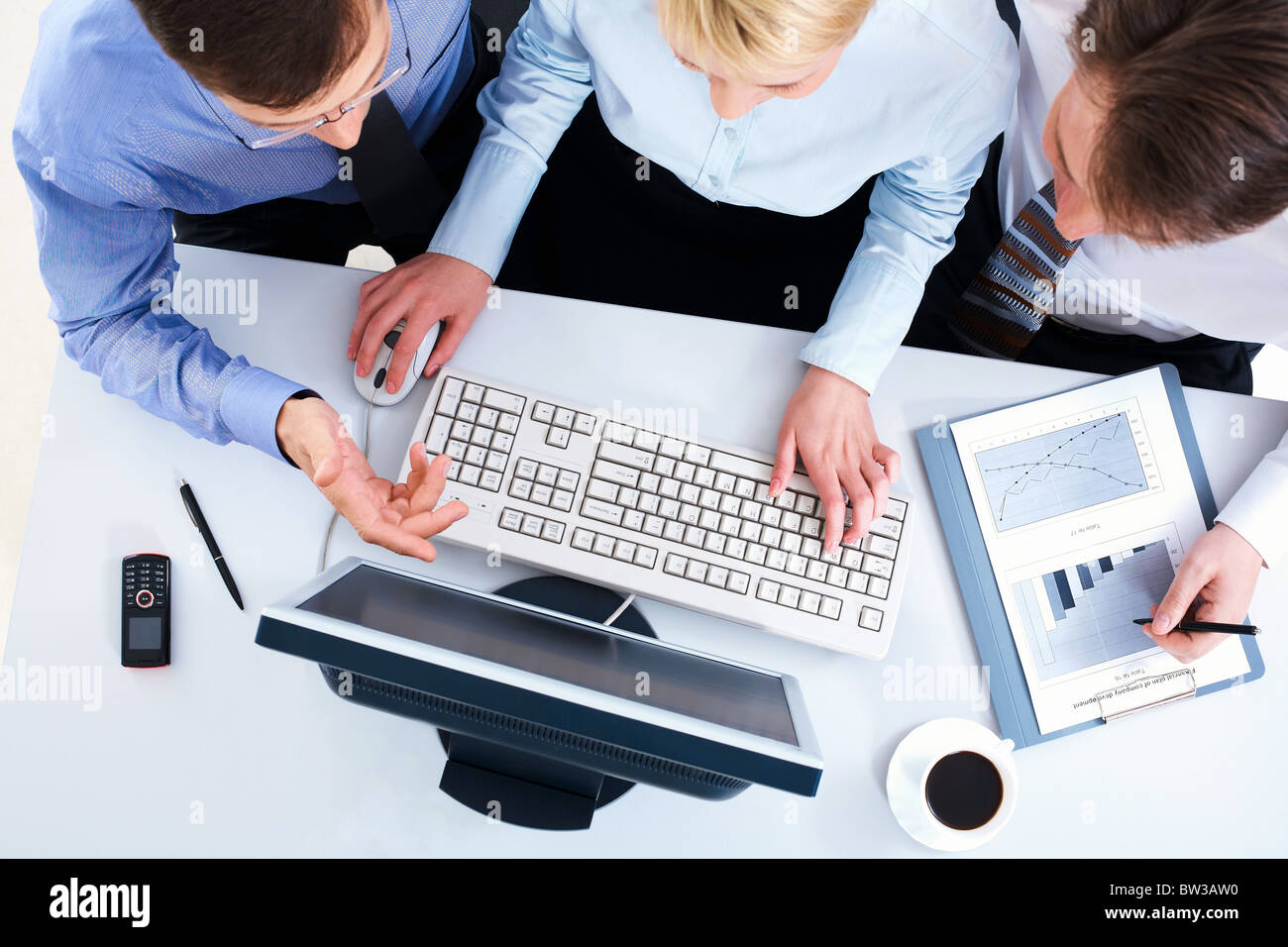 Above view of successful co-workers doing computer work together Stock ...
