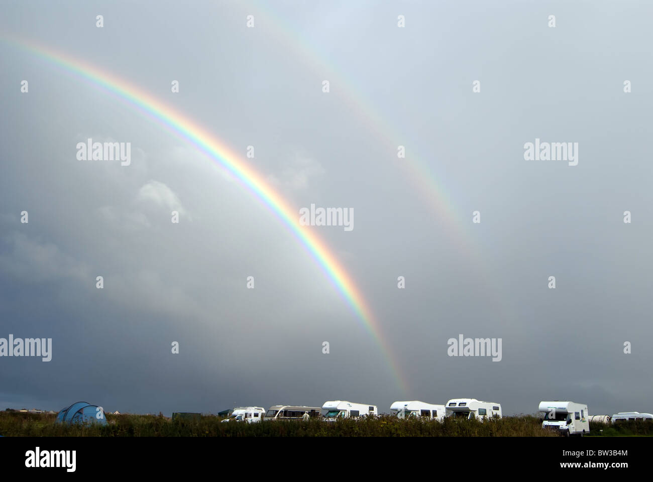 colorful rainbow at the sky over the campsite Stock Photo - Alamy