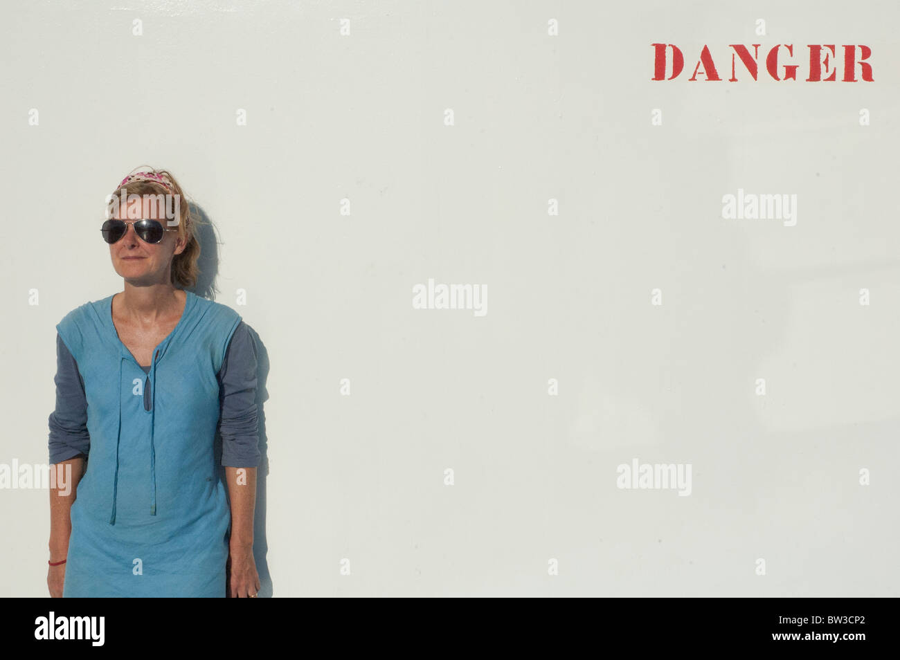 girl with danger sign Stock Photo - Alamy