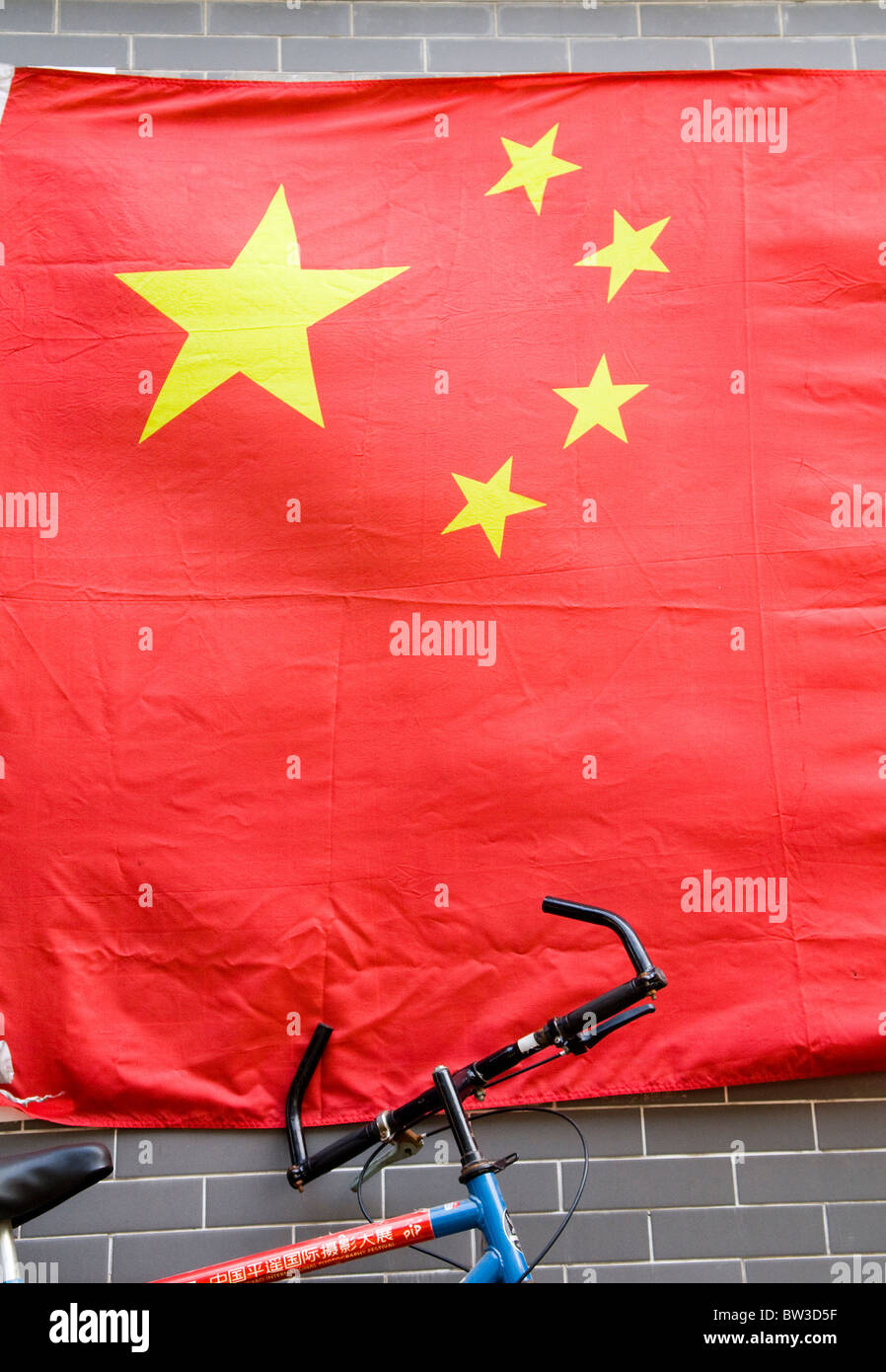 Cycle and the red flag Stock Photo - Alamy