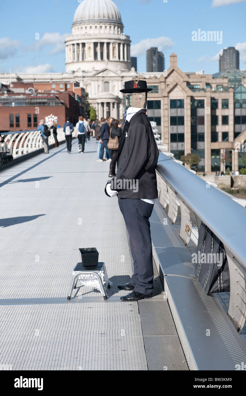 Group of people walking over the Millenium Bridge London in distance ...