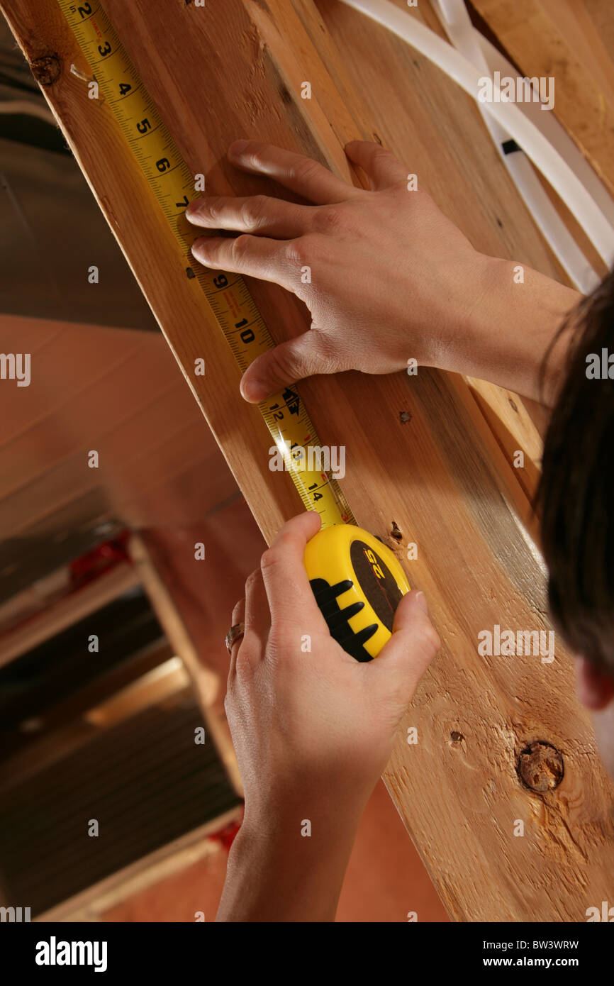 Carpenter using measuring tape Stock Photo - Alamy