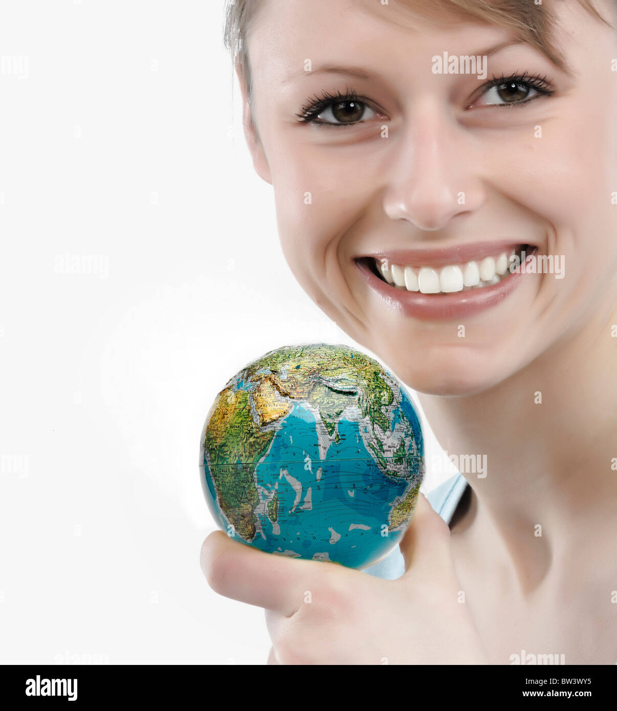 Beautiful young woman holding a little world Stock Photo - Alamy