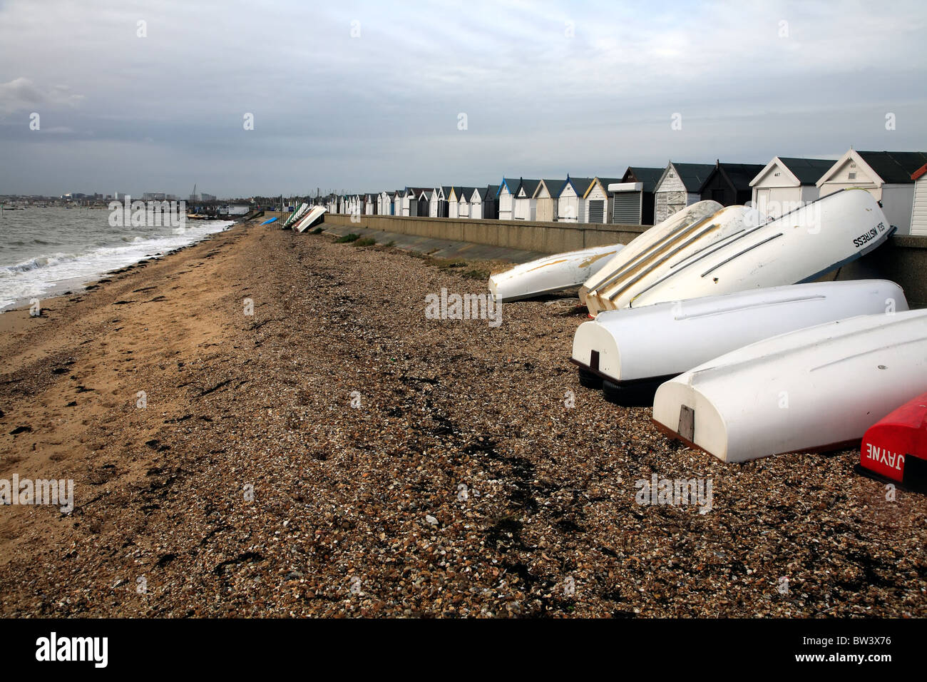 sand and shingle beach with huts and dinghy's at Southend in Essex out ...