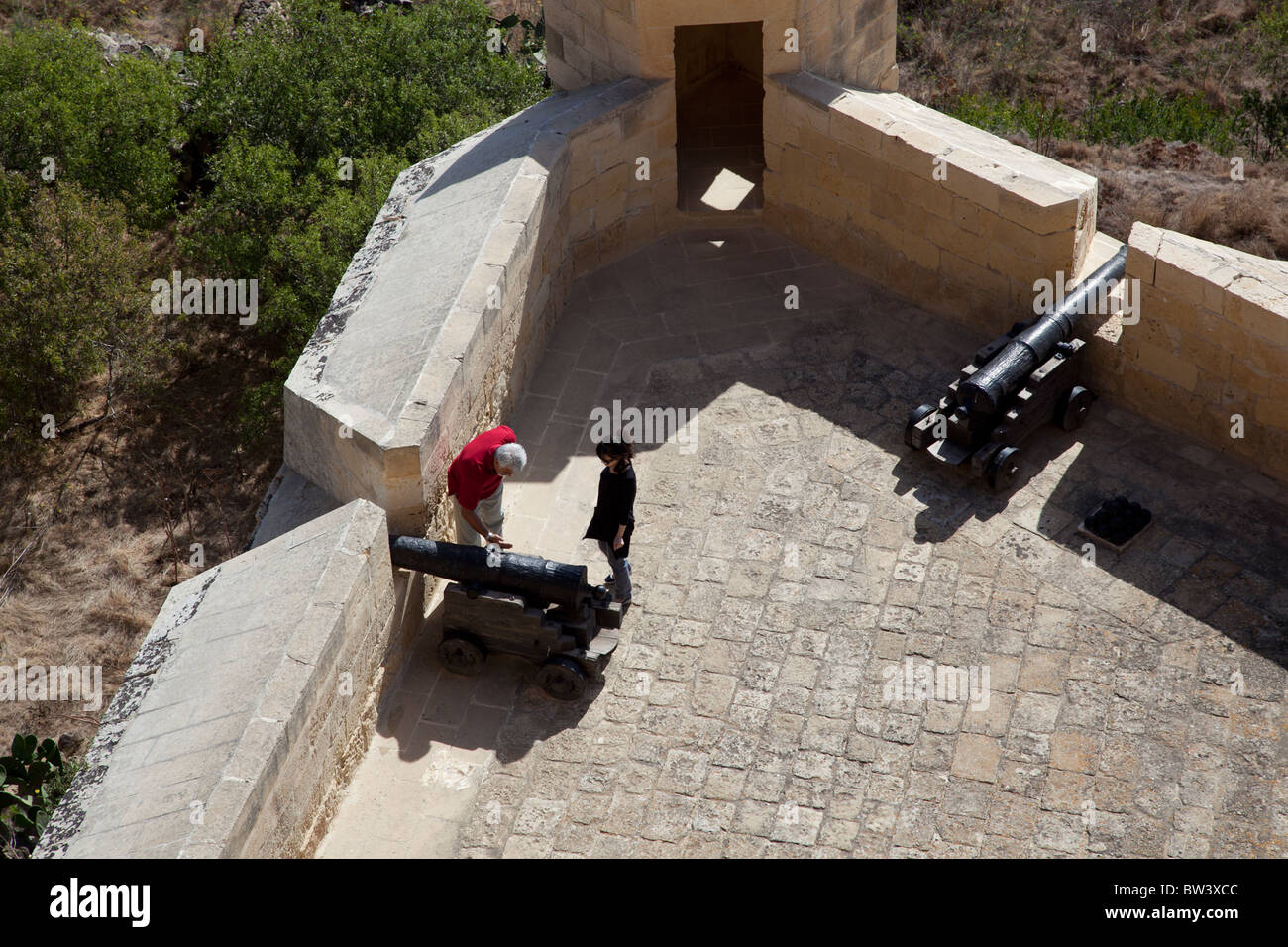 Visitors explore historical cannons at the battery jutting out of the ...