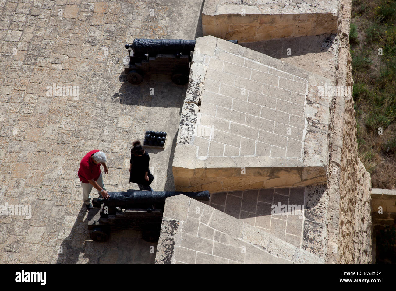 Visitors explore historical cannons at the battery jutting out of the ...