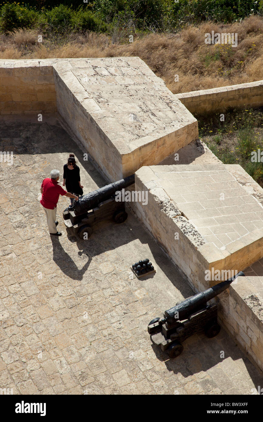 Visitors explore historical cannons at the battery jutting out of the ...