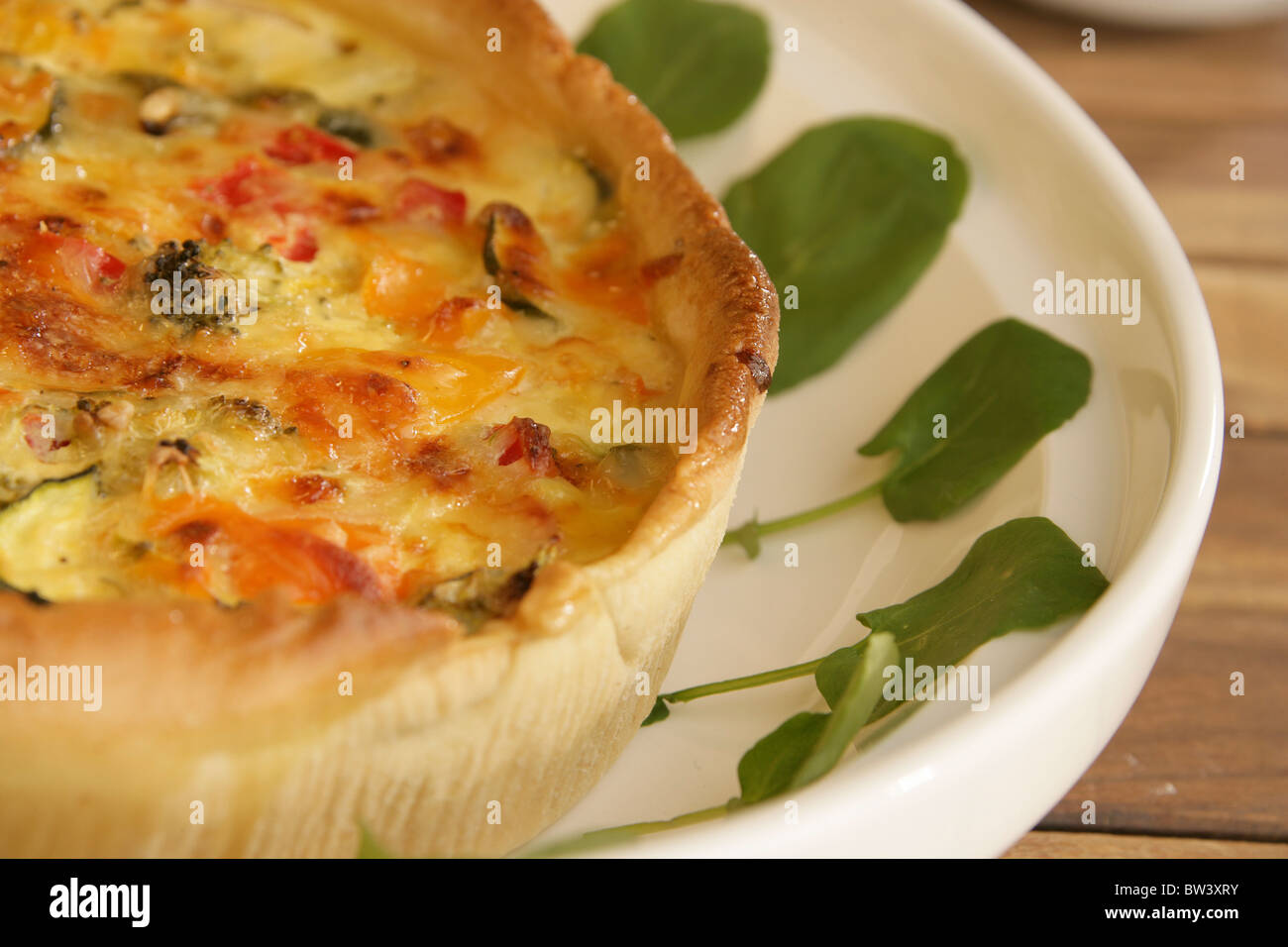 Quiche in bowl with spinach Stock Photo - Alamy