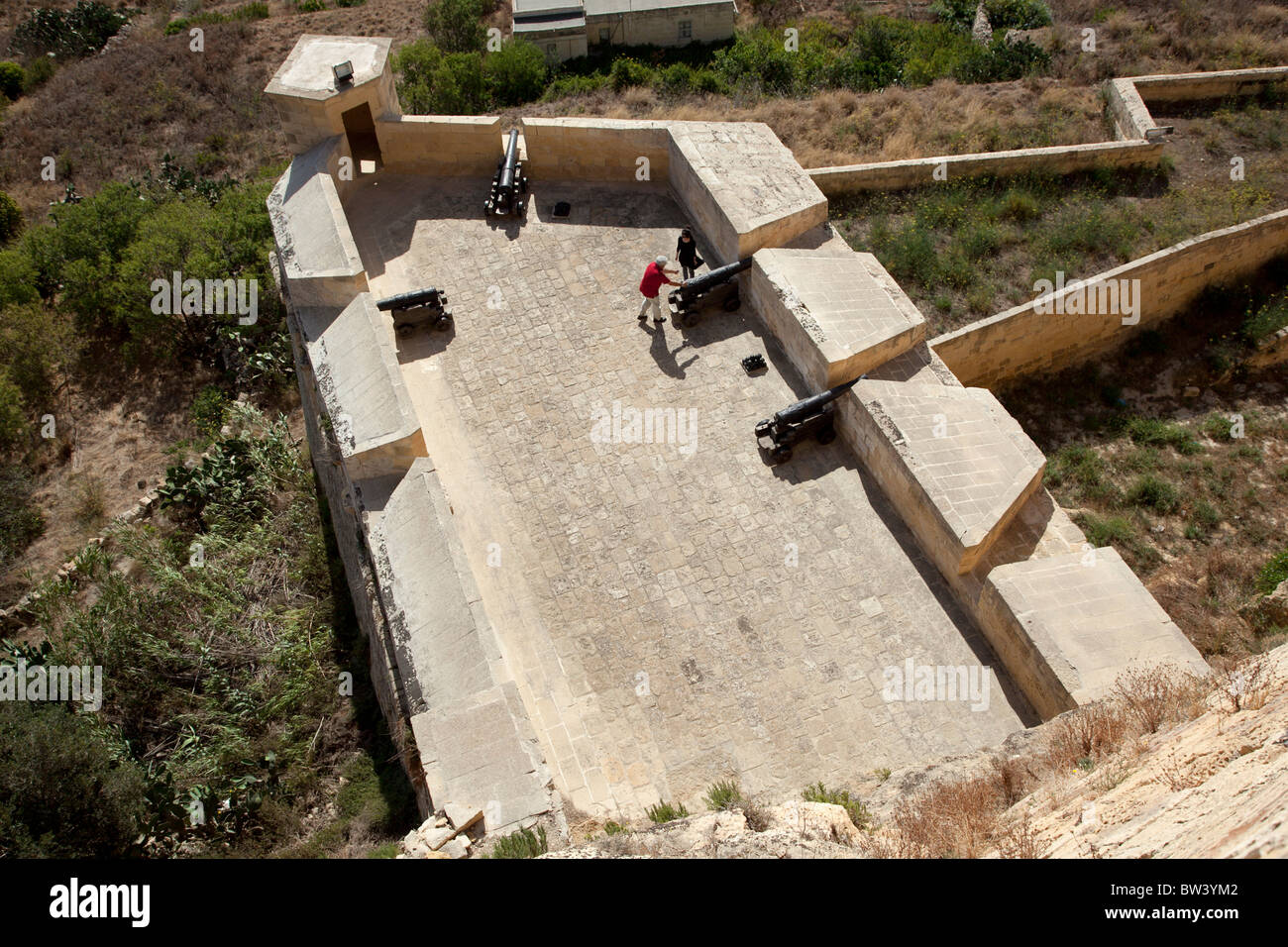 Visitors explore historical cannons at the battery jutting out of the ...