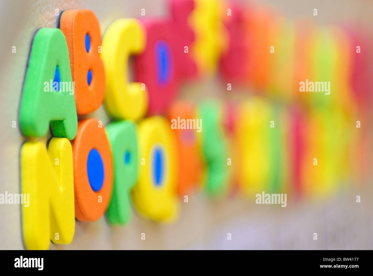 Multicolored refrigerator magnets that are letters of the alphabet are ...