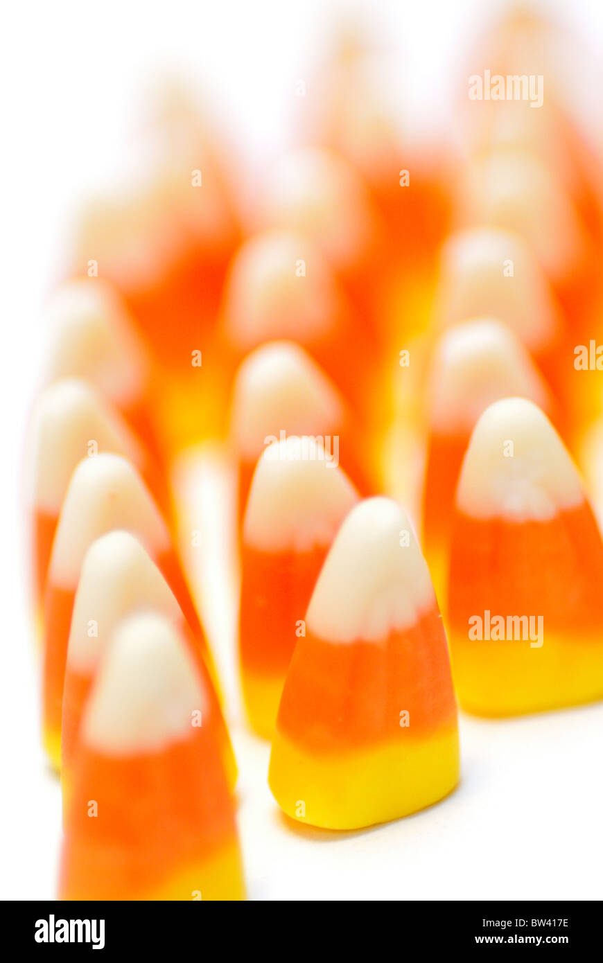 Many Halloween candy corn lined up in long rows, with a shallow depth ...