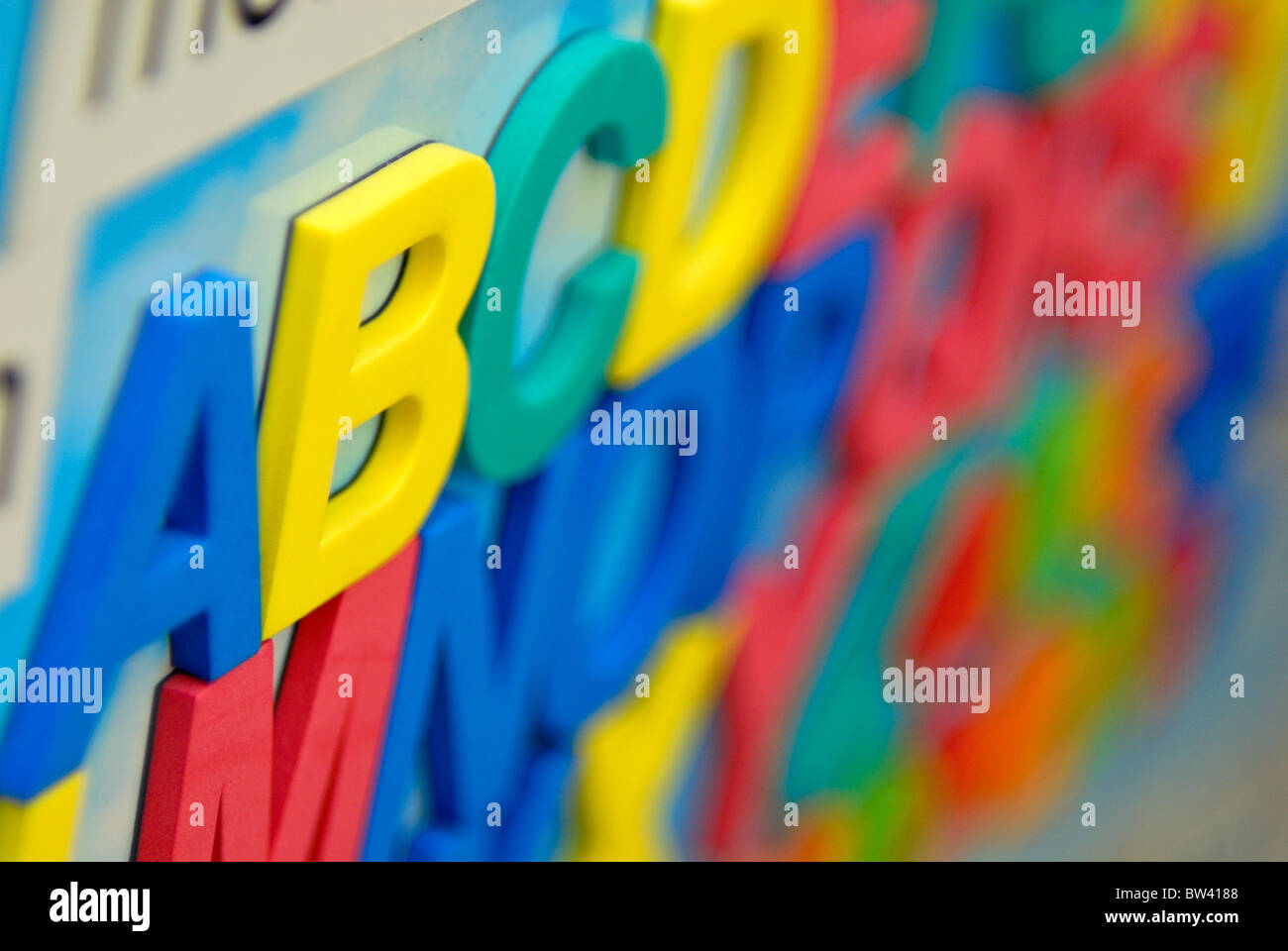 Multicolored refrigerator magnets that are letters of the alphabet are ...