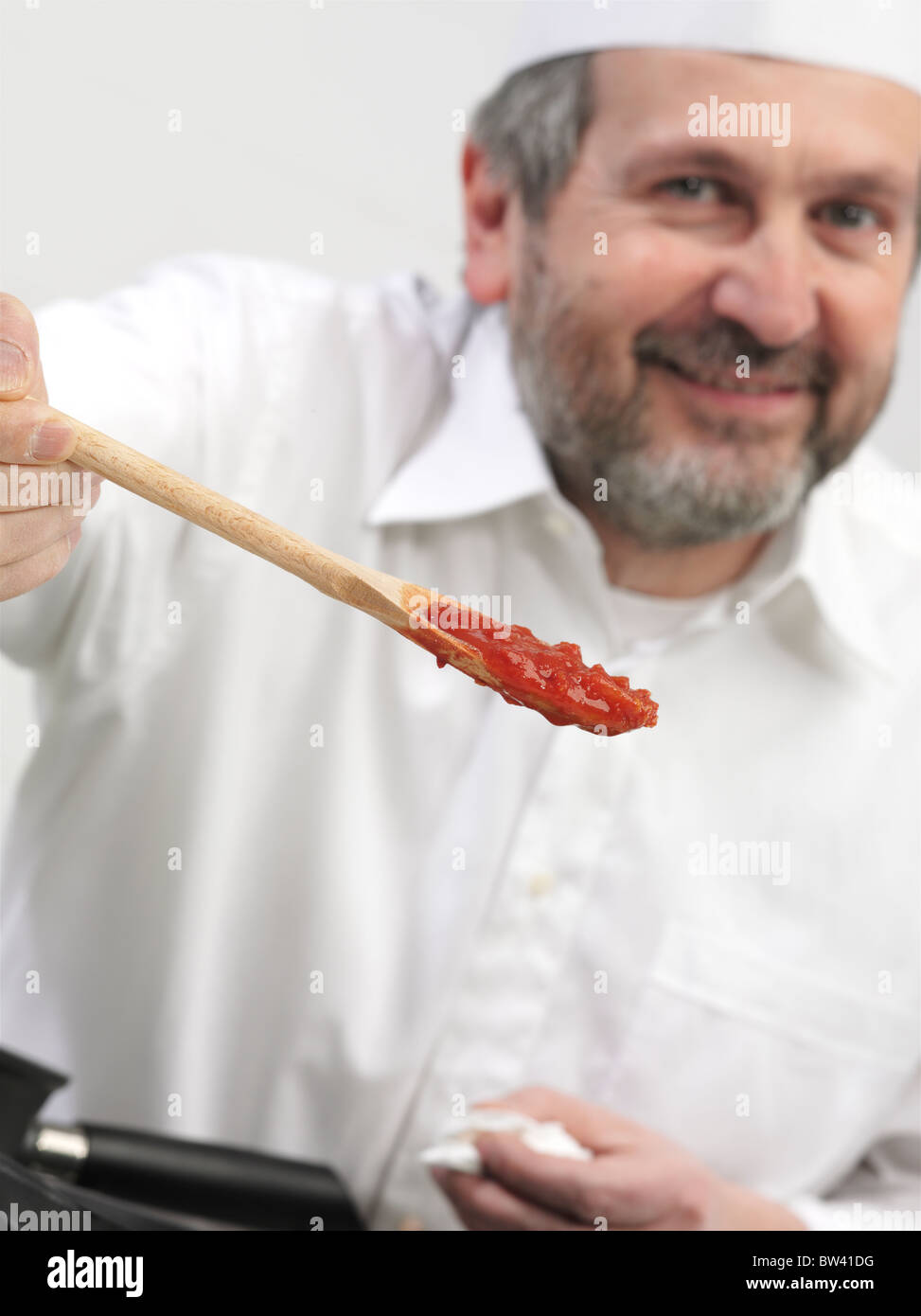 Cook in a kitchen, making a delicious dish Stock Photo - Alamy