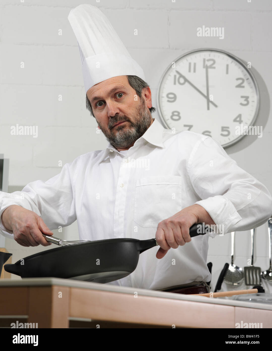 Cook in a kitchen, making a delicious dish Stock Photo - Alamy