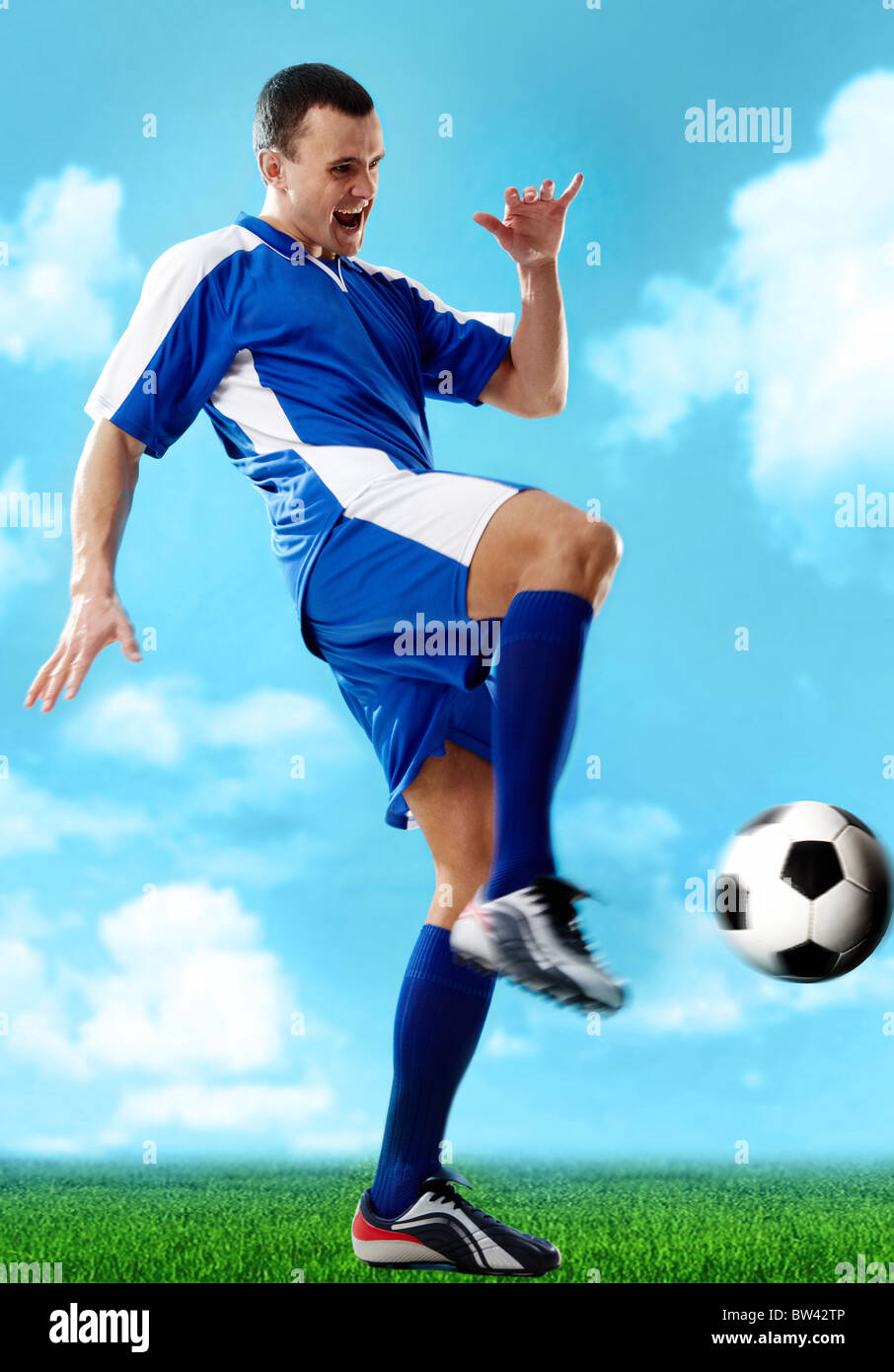 Portrait of soccer player hitting the ball Stock Photo - Alamy